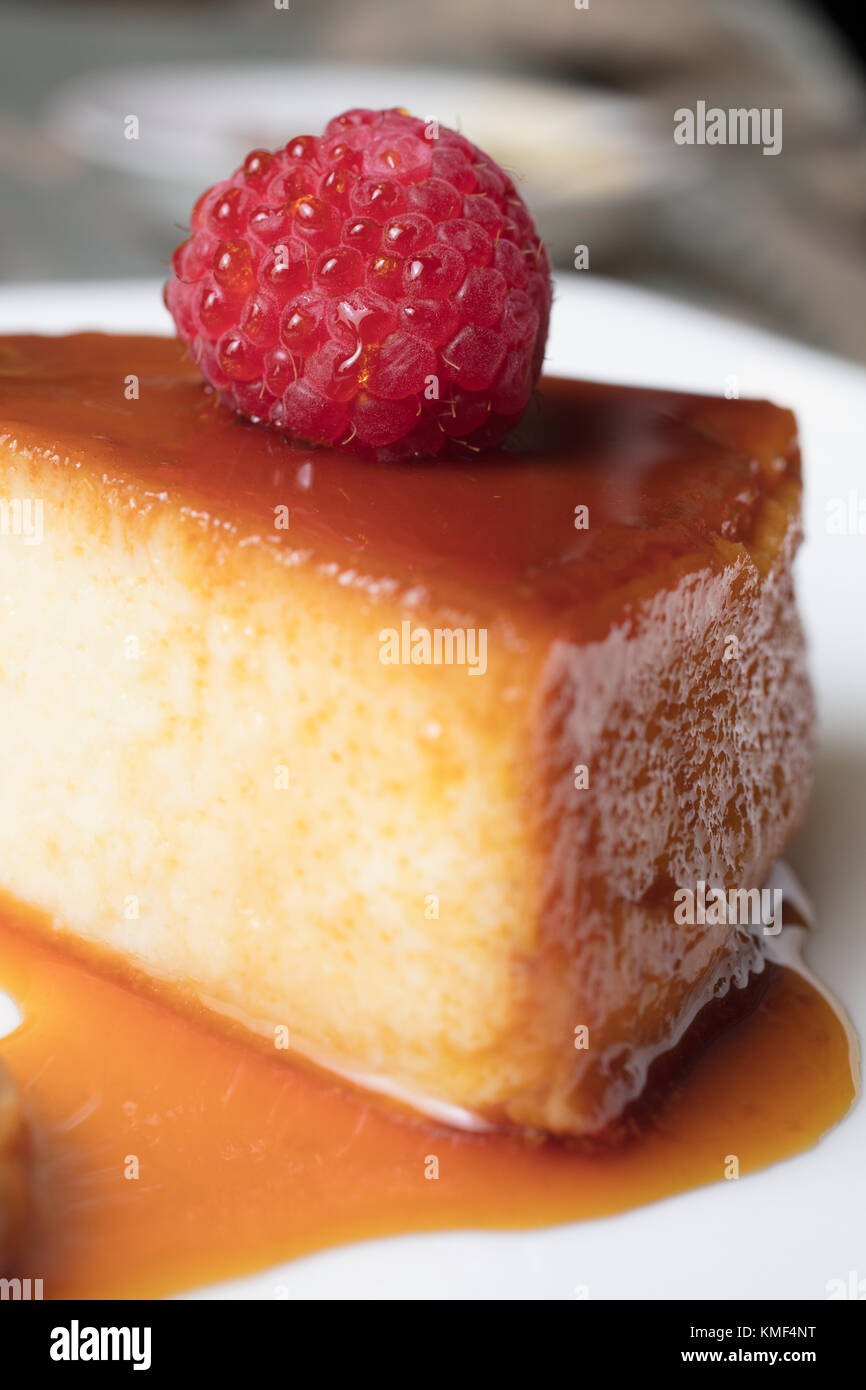 Creamy Flan dessert served with raspberries and dulce de leche served ...