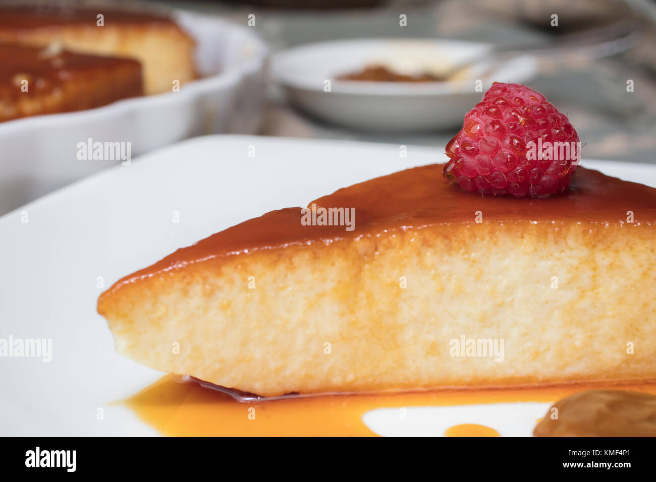 Creamy Flan dessert served with raspberries and dulce de leche served ...