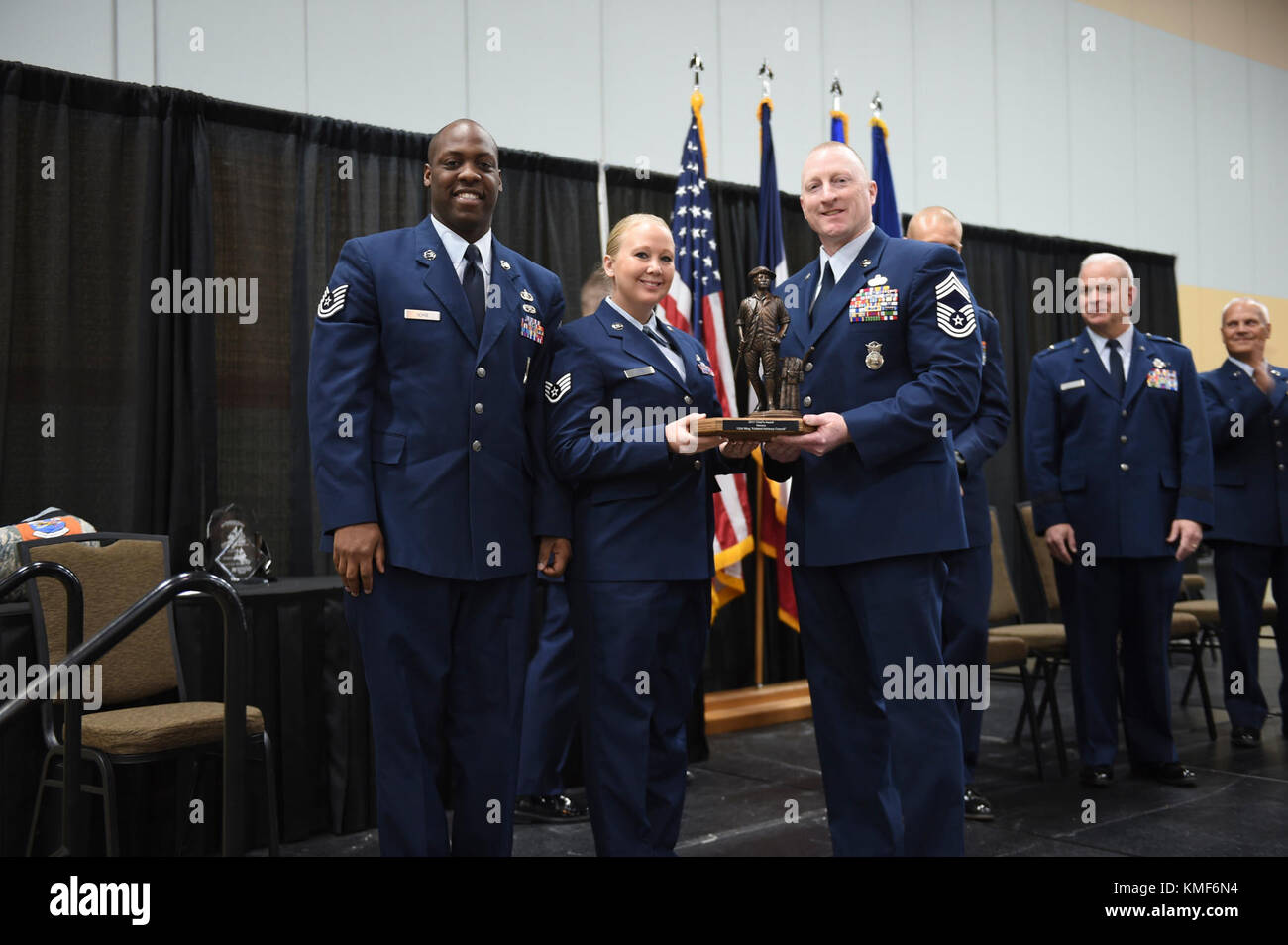 Chief Master Sgt. John Smith poses with Staff Sgt. Jaime Young and Tech ...