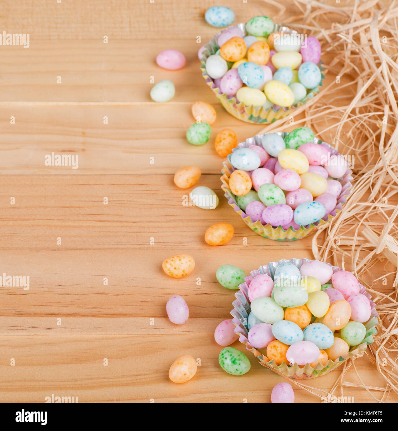 Colorful Easter jelly beans in paper cups on a wood background Stock ...