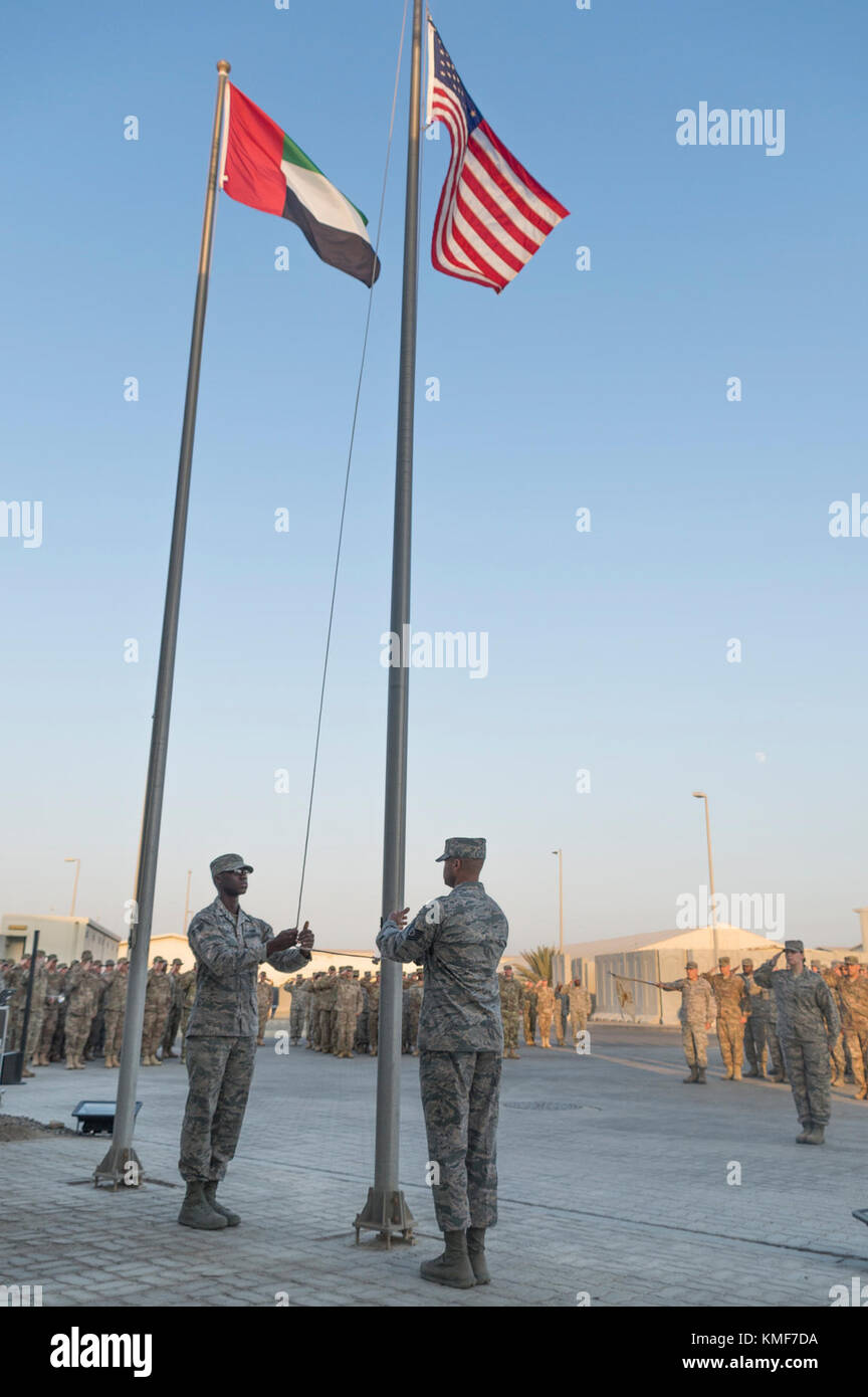 Airmen from the 380th Air Expeditionary Wing honor guard lower the U.S ...