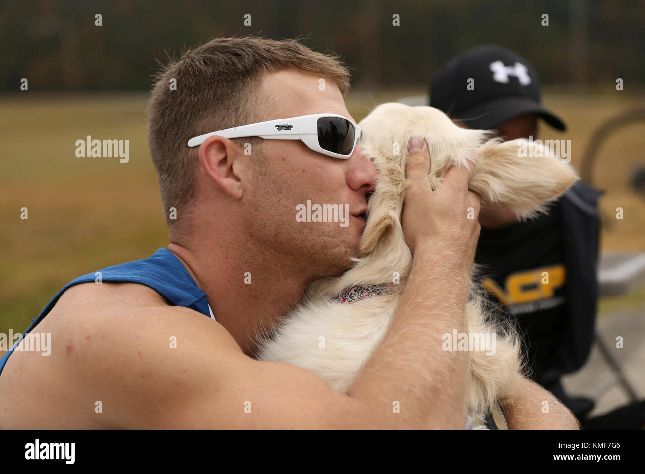 U.S. Army Sgt. Sean Michael-Horn hugs Katie, a service dog, after the ...