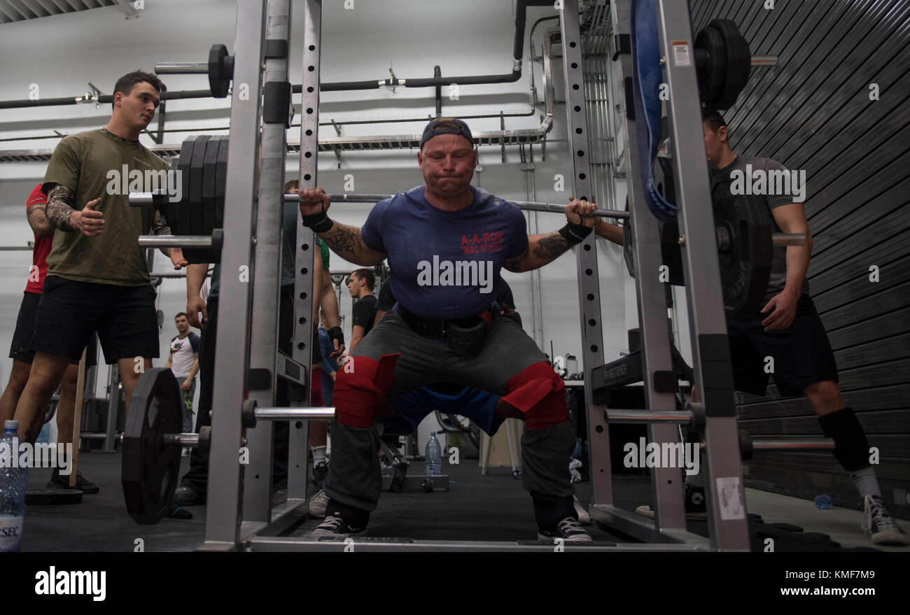 Chief Master-at-Arms Aaron Moore, center, assigned to Naval Support ...