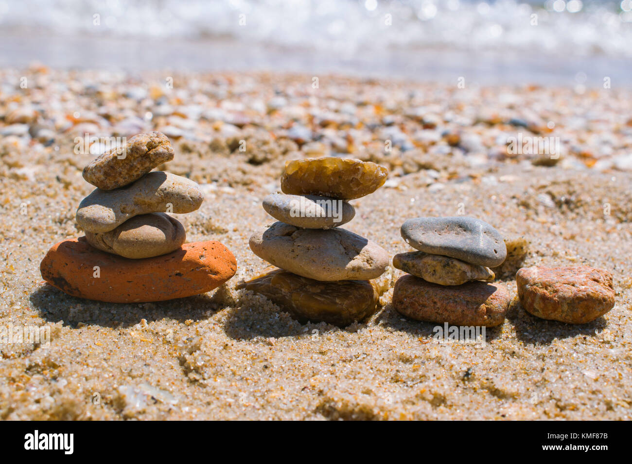 Stone pyramid on the sea near the waves Stock Photo - Alamy