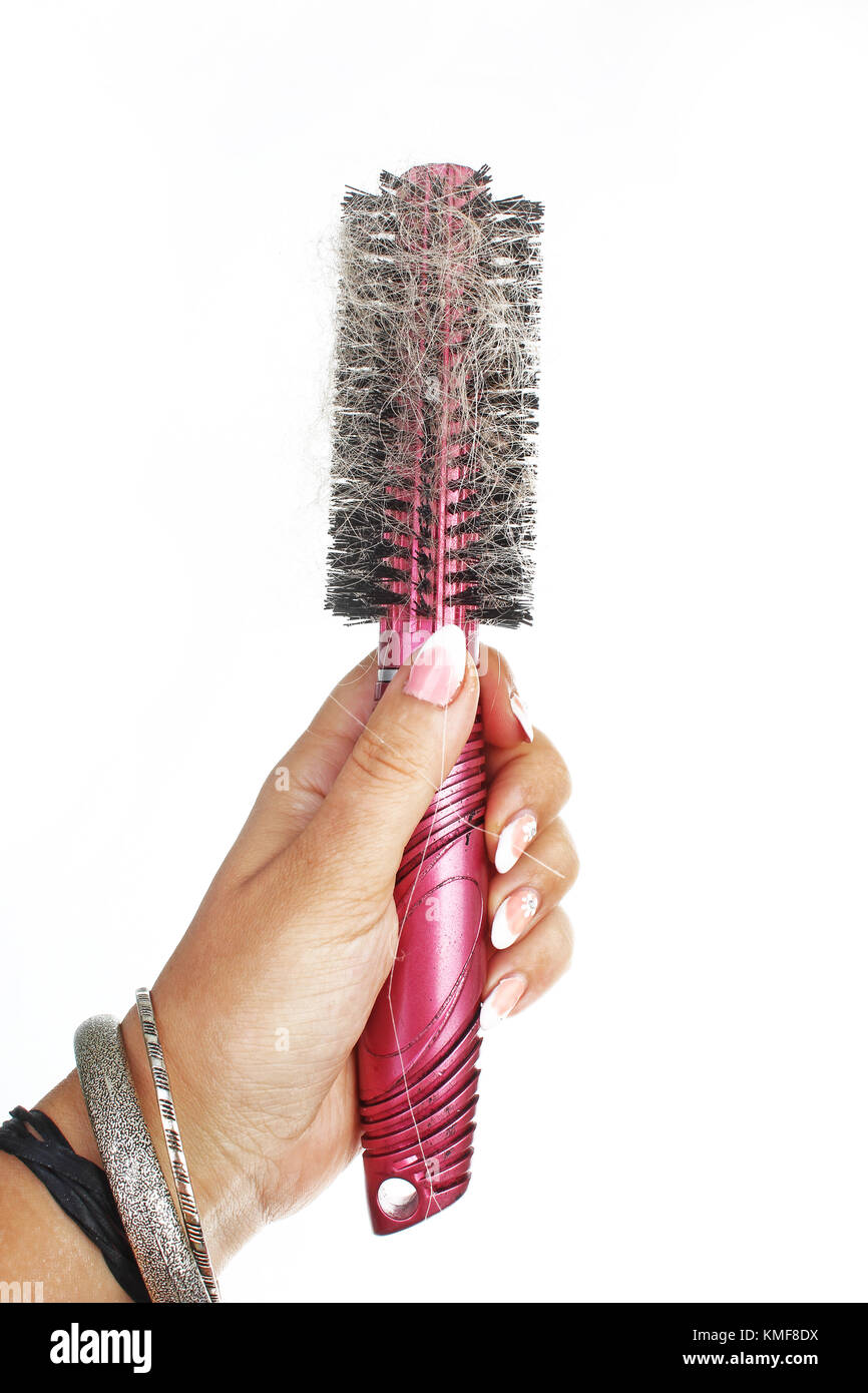 Woman hand holding comb on isolated white cutout background. Studio ...