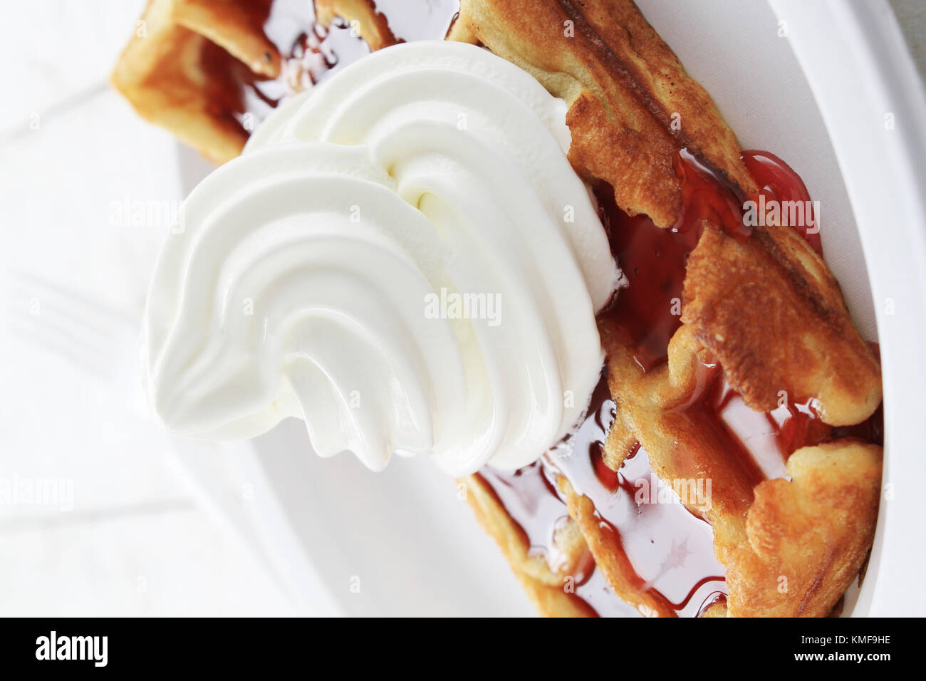 traditional waffle with cream and syrup Stock Photo - Alamy