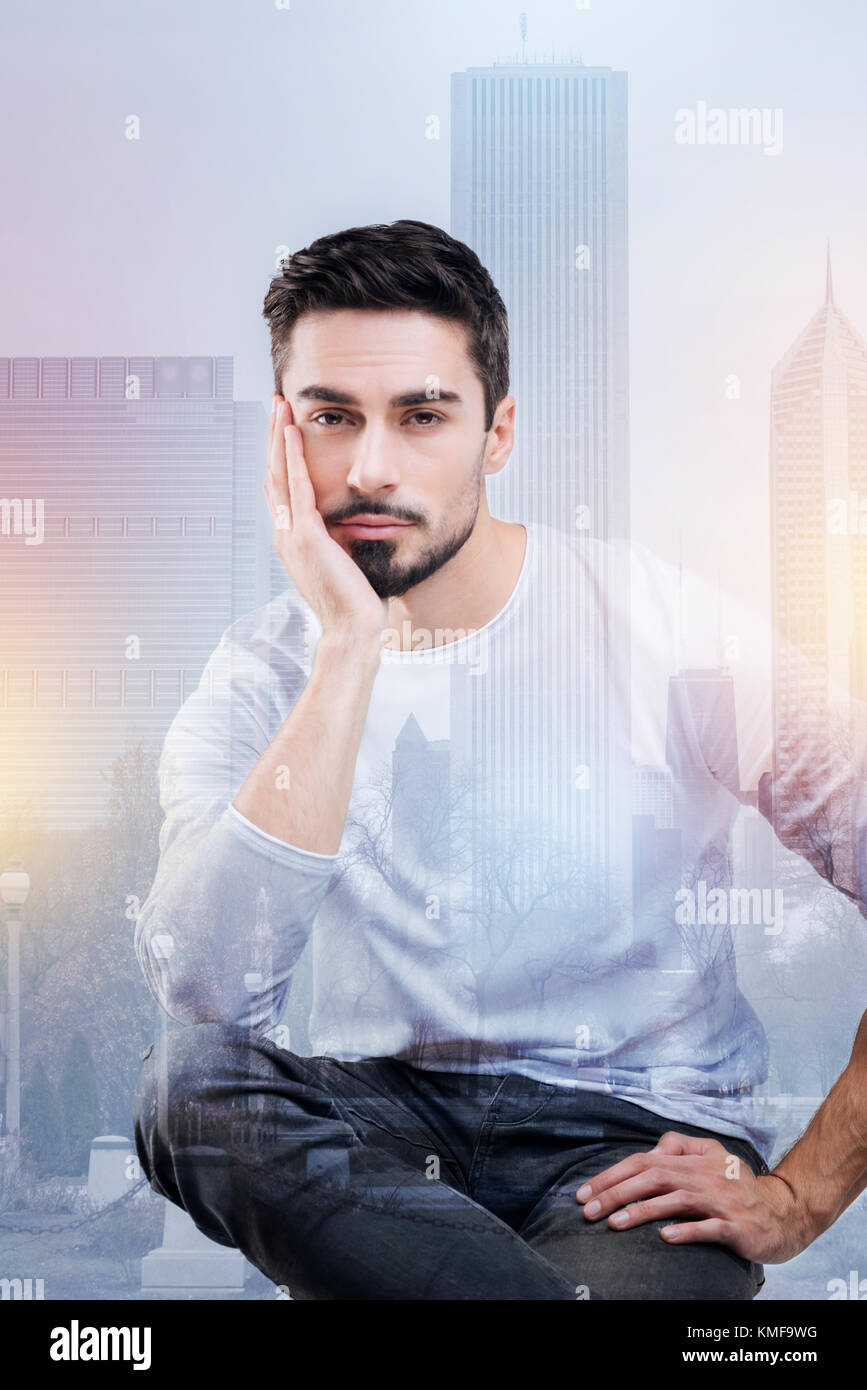 Tired handsome student resting head on piles of books in library Stock ...