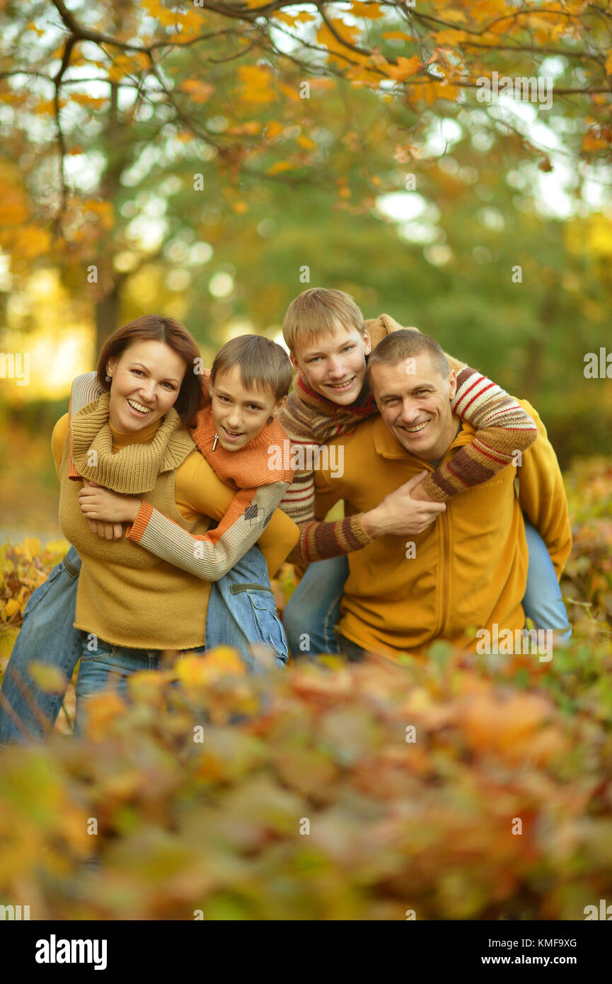 smiling family in autumn forest Stock Photo - Alamy