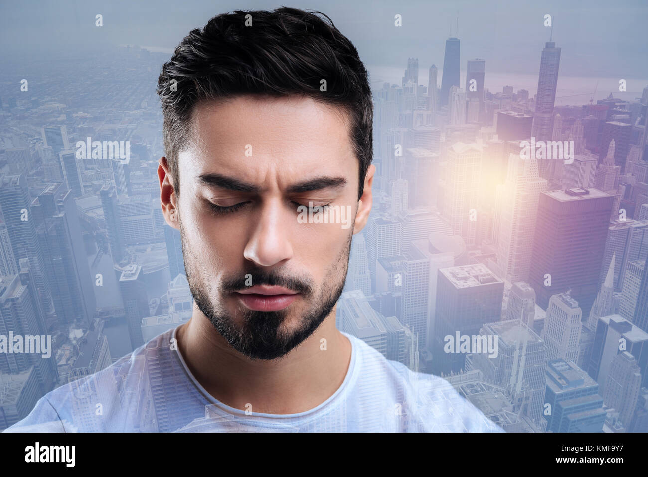 Calm peaceful man meditating while being alone Stock Photo - Alamy