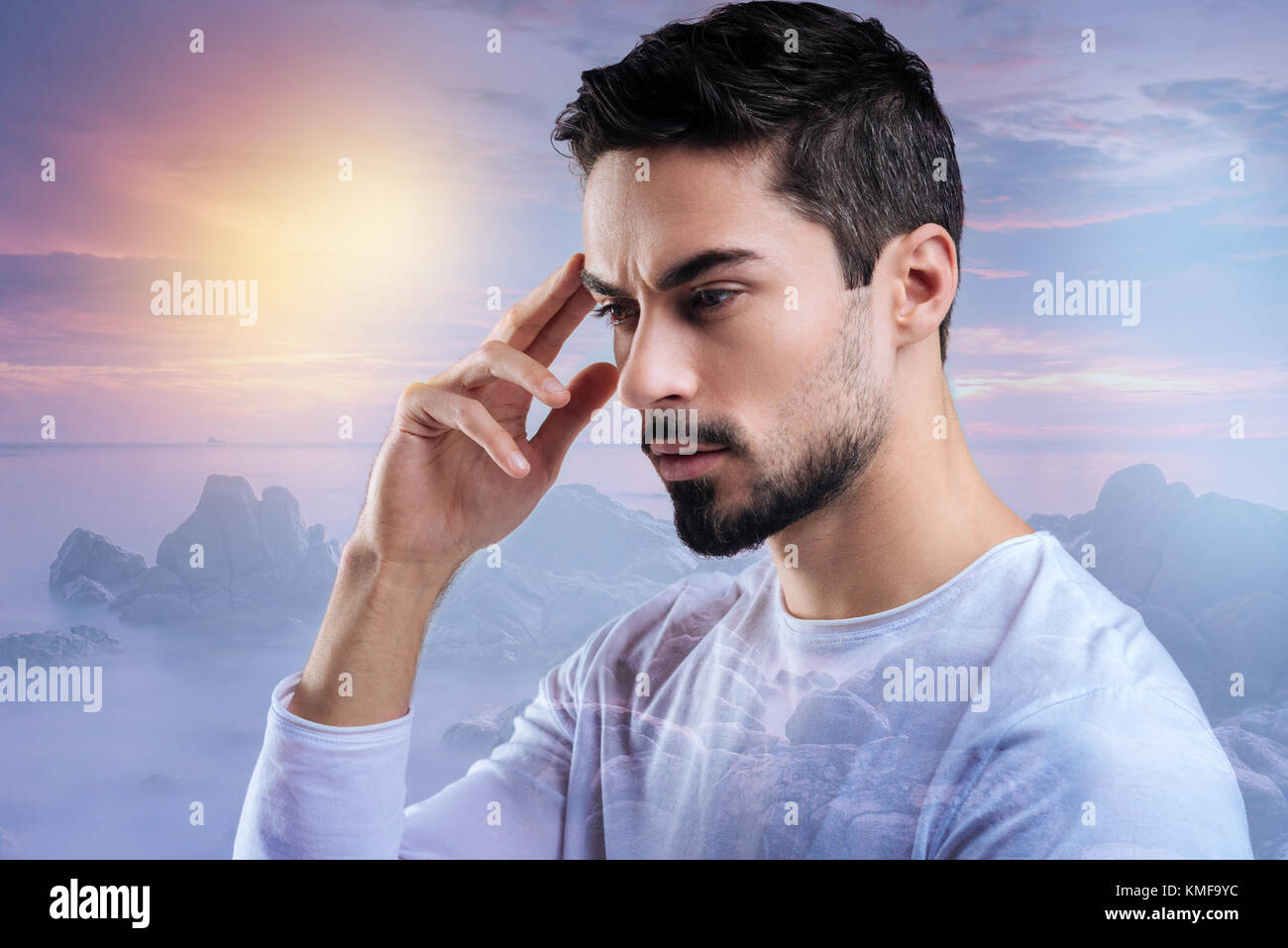 Smart young engineer thinking about an urgent problem and touching his ...