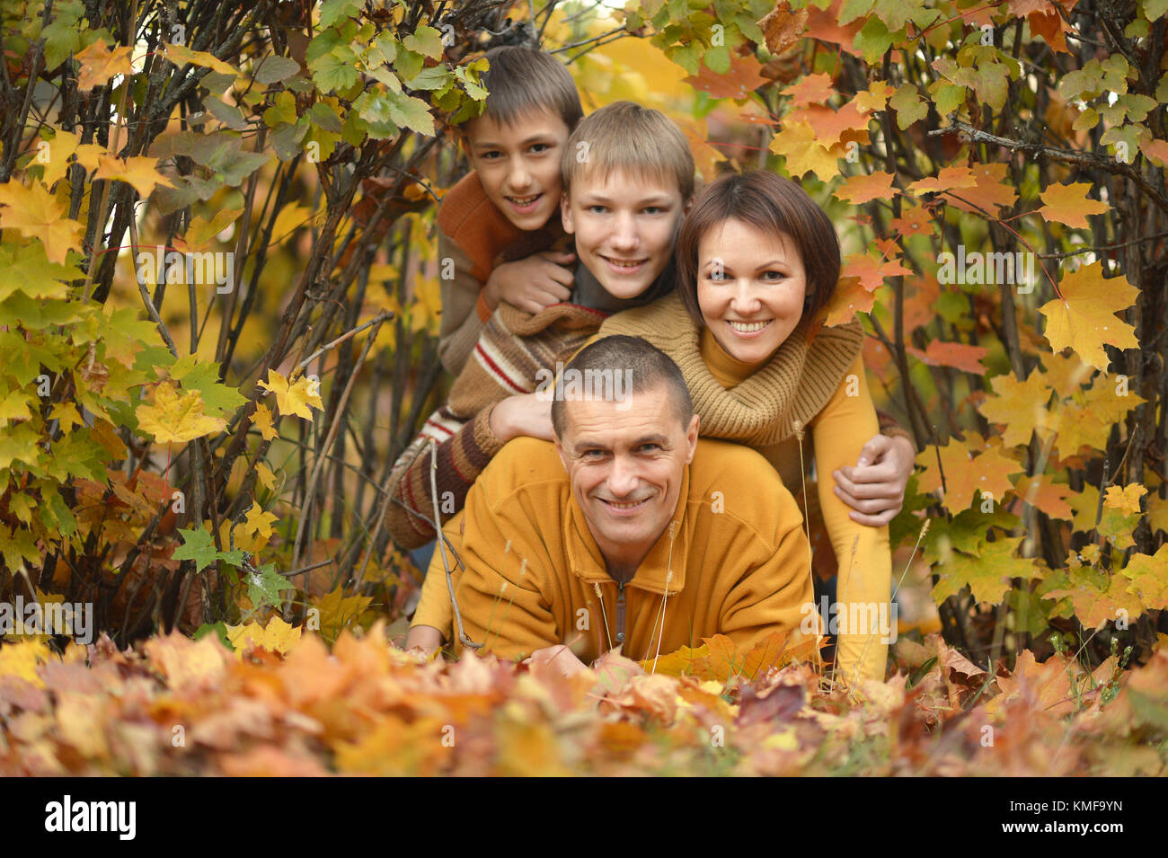 smiling family in autumn forest Stock Photo - Alamy
