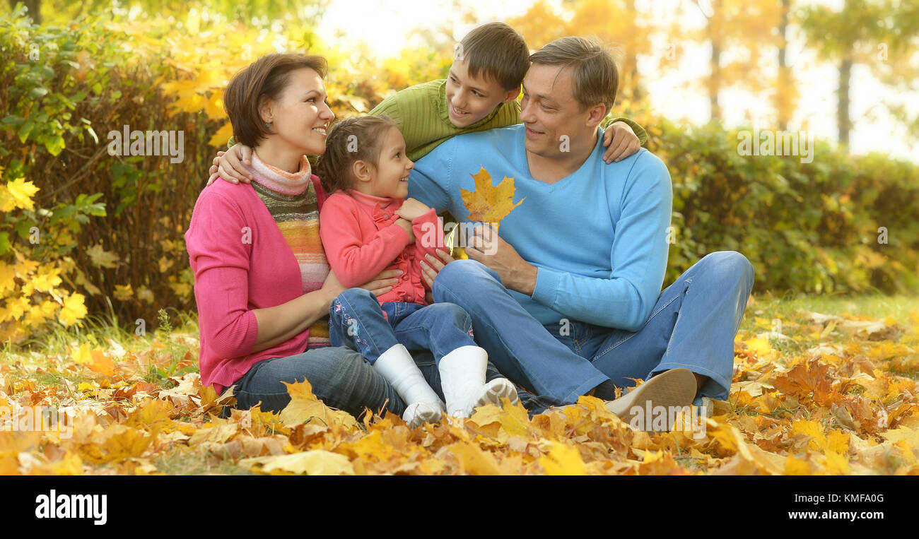 Family in autumn park Stock Photo - Alamy