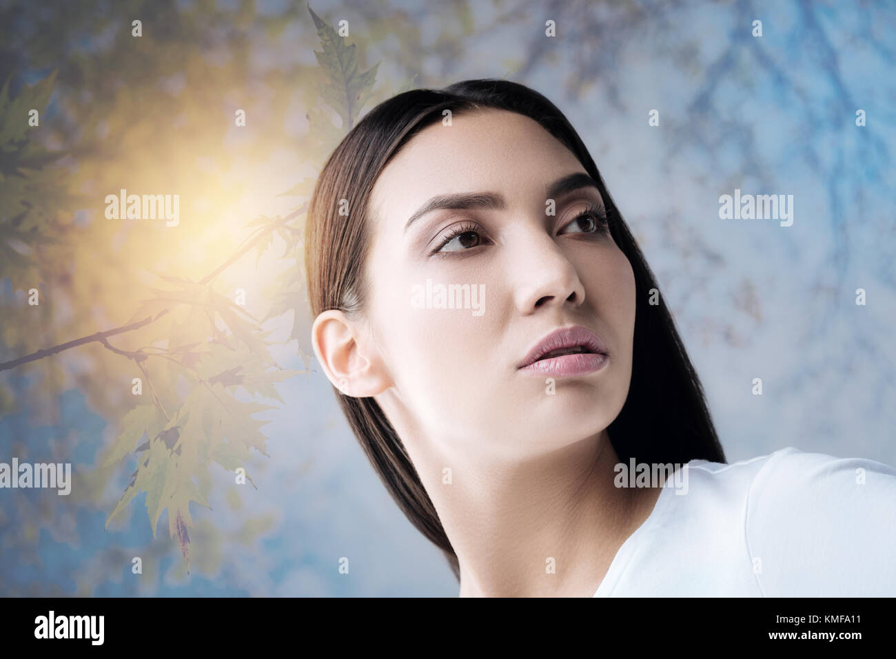Pretty young woman looking romantic while standing in a garden Stock ...