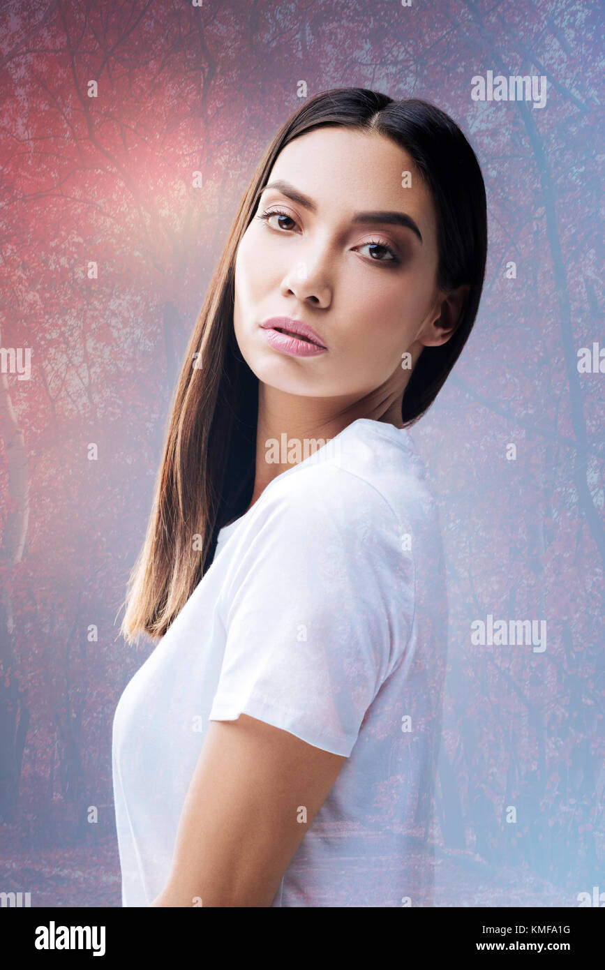 Cute emotional model working while posing for a professional ...