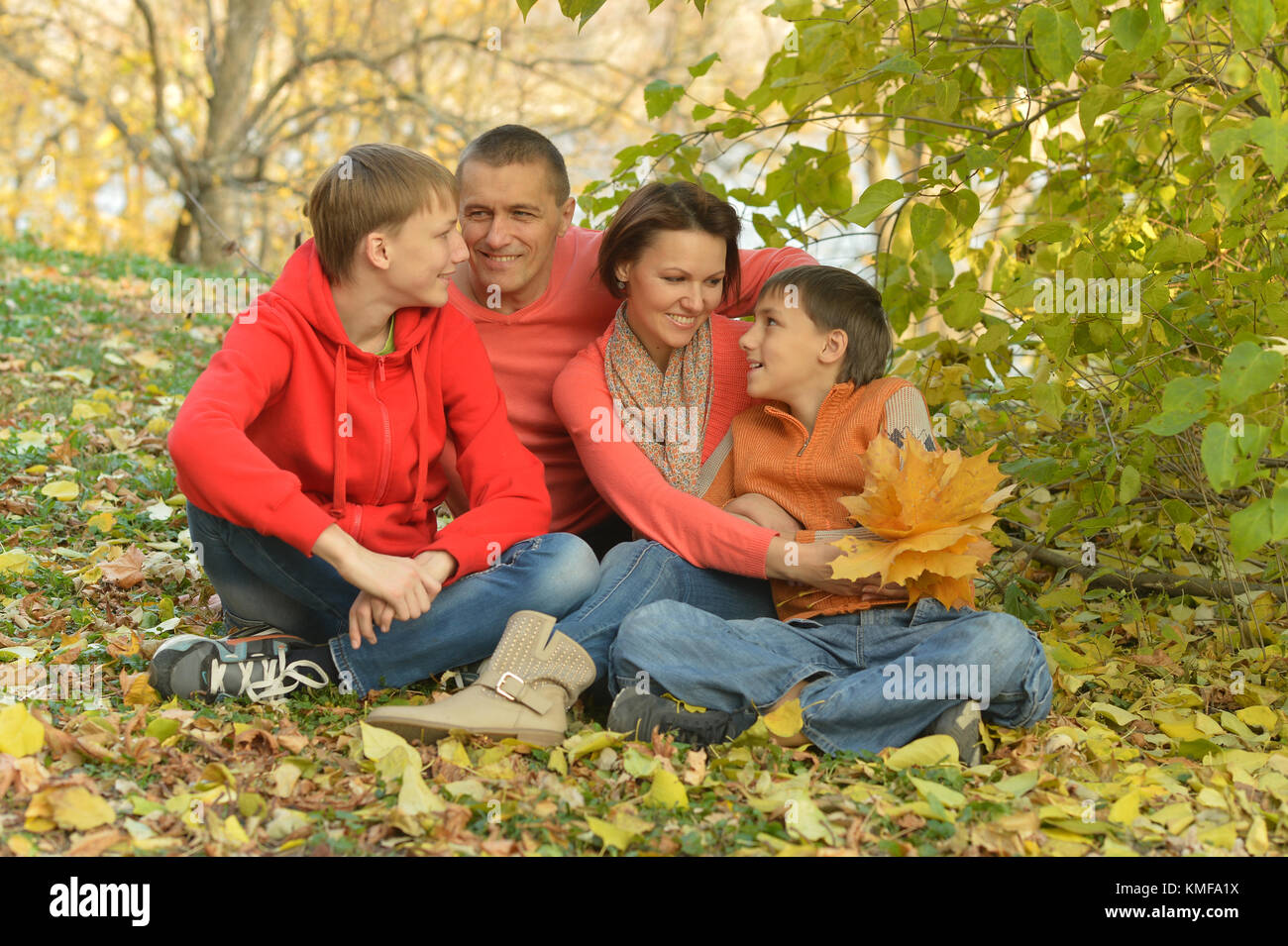 Family in autumn park Stock Photo - Alamy