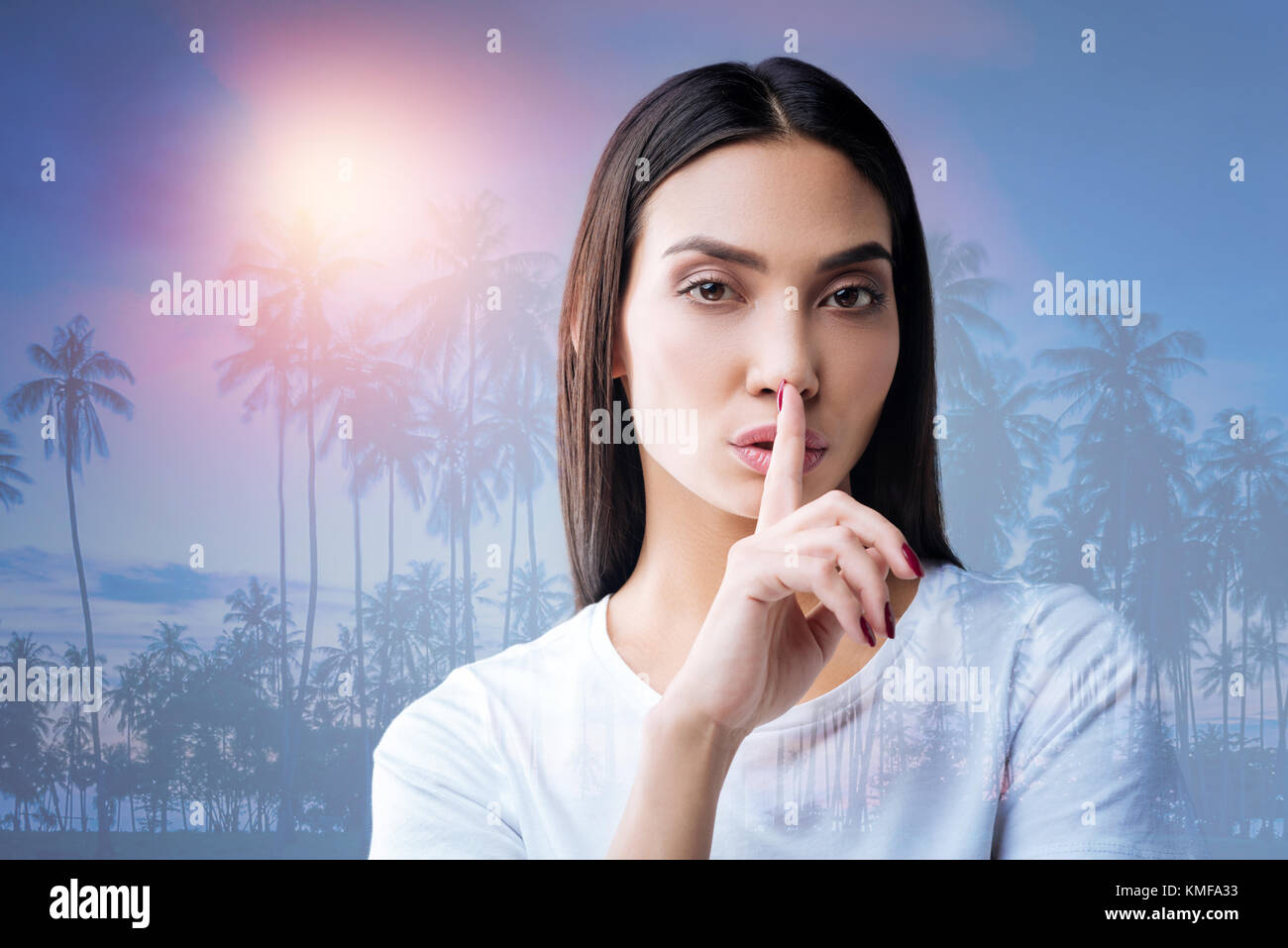 Pretty young teacher showing her teacher to be quiet while teaching ...
