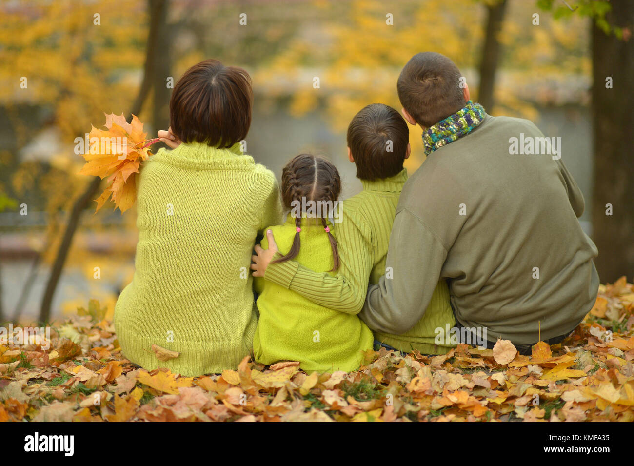 Family in autumn park Stock Photo - Alamy