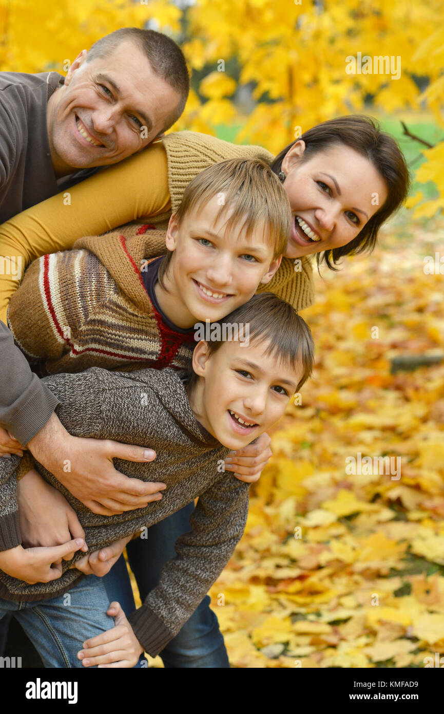 smiling family in autumn forest Stock Photo - Alamy