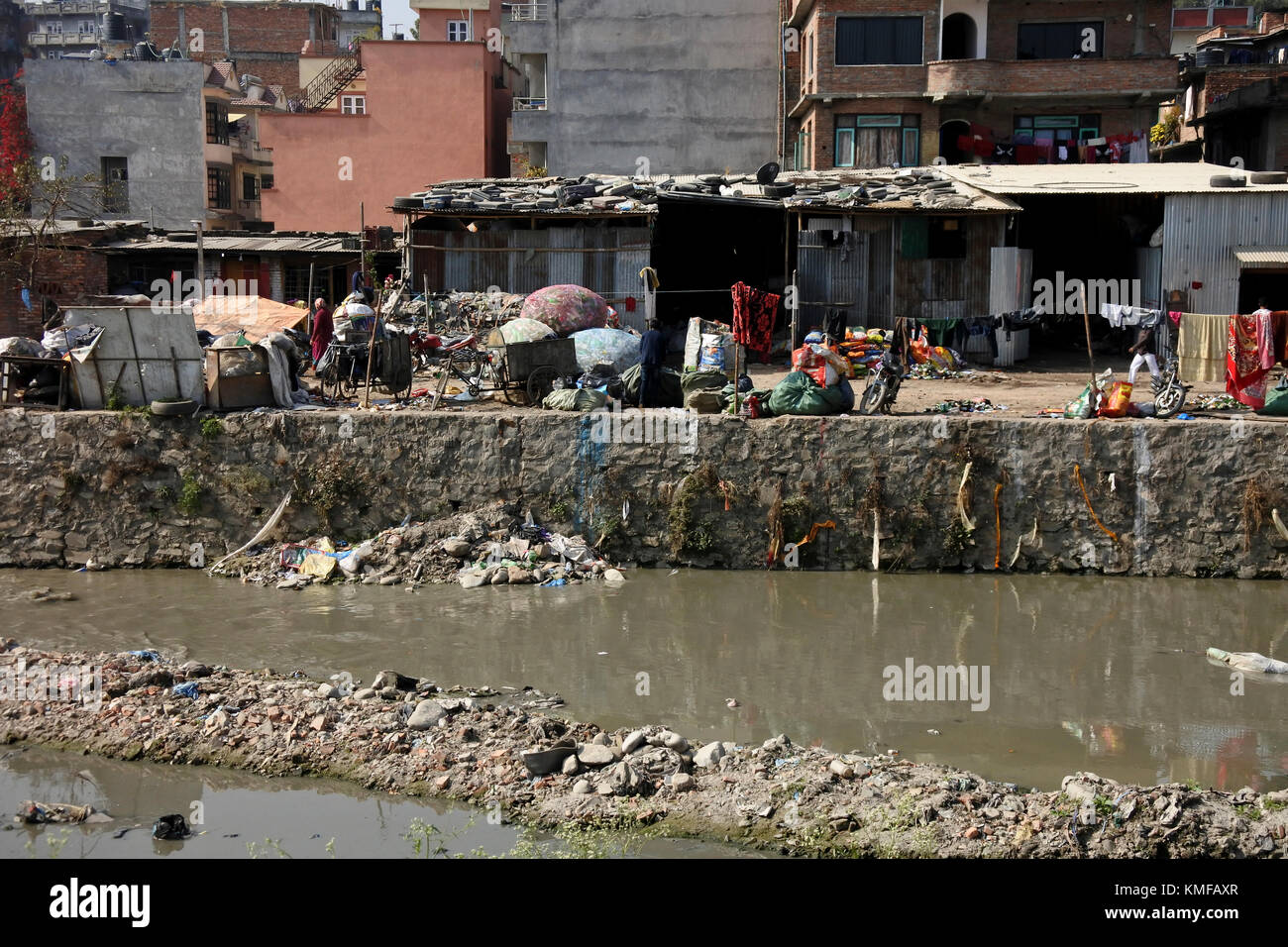 Mounts of plastic bags, dust and build up over many years in a river ...