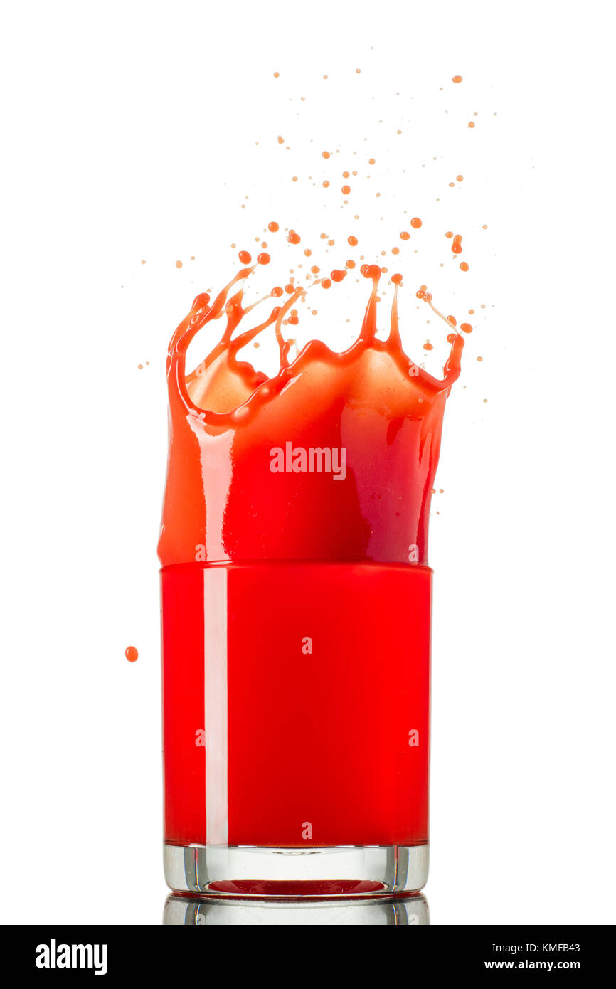 Tomato juice splash out from a glass isolated on white Stock Photo - Alamy