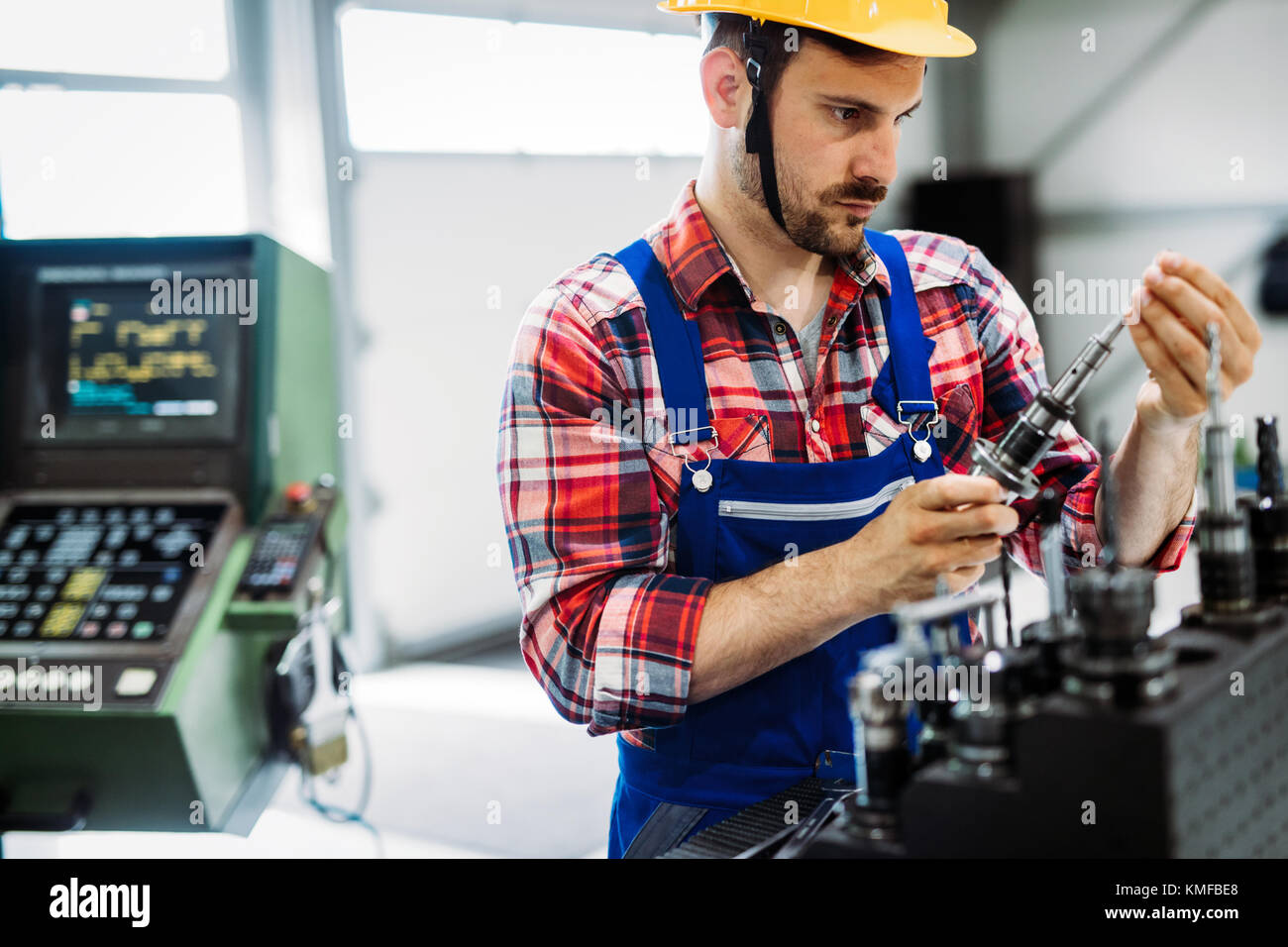 modern industrial machine operator working in factory Stock Photo - Alamy