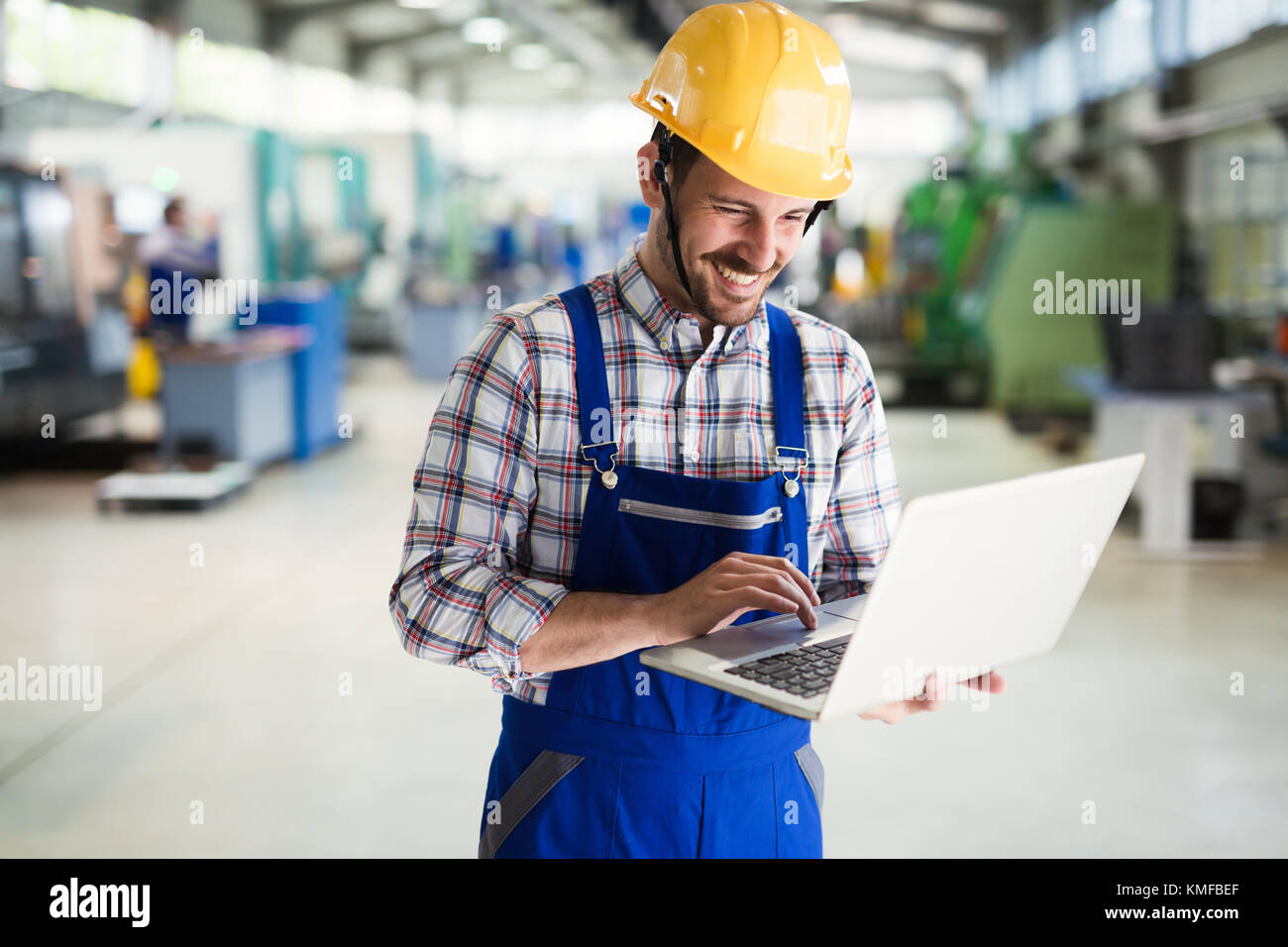 modern industrial machine operator working in factory Stock Photo - Alamy