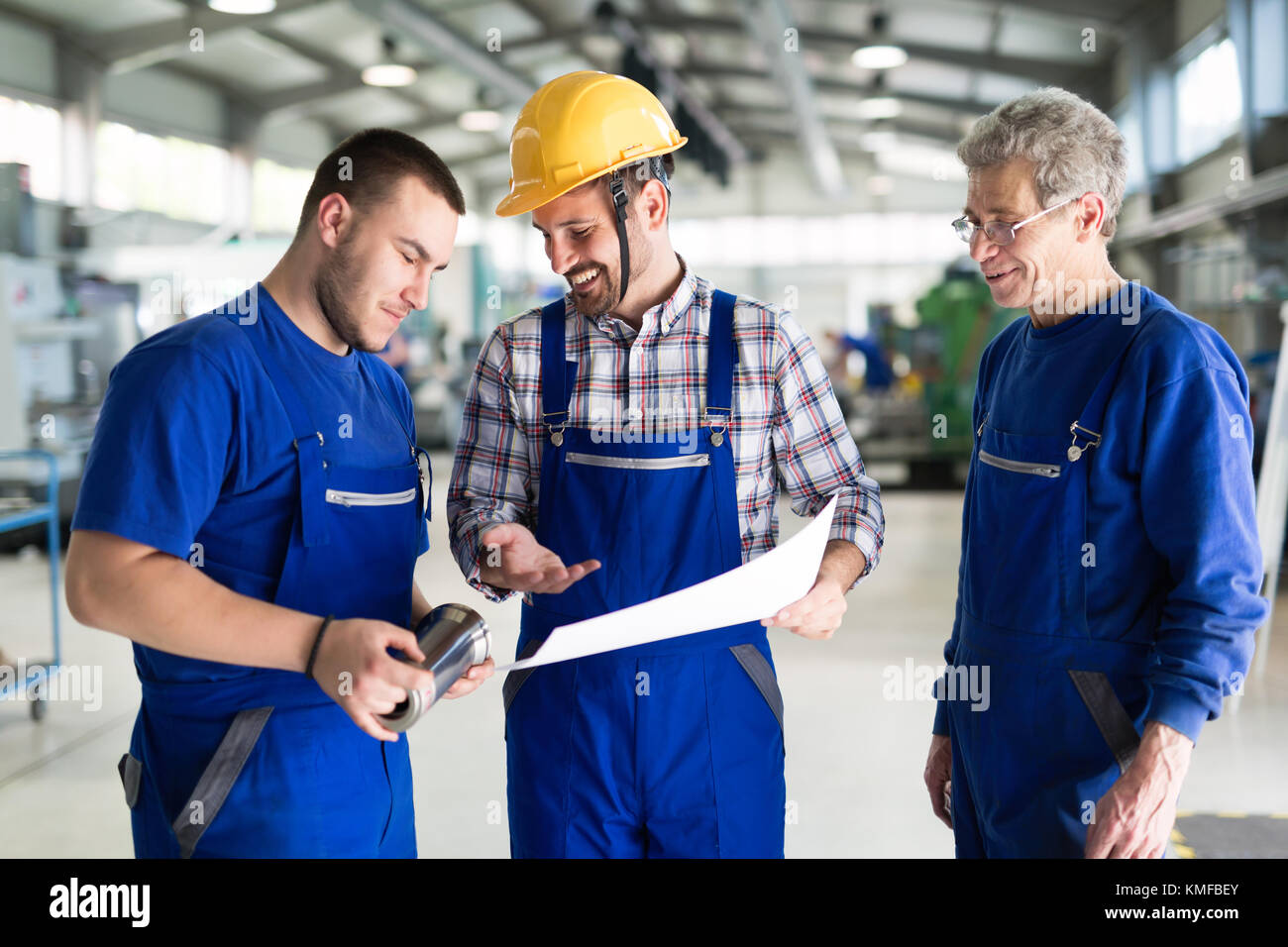Team Of Engineers Having Discussion In Factory Stock Photo - Alamy