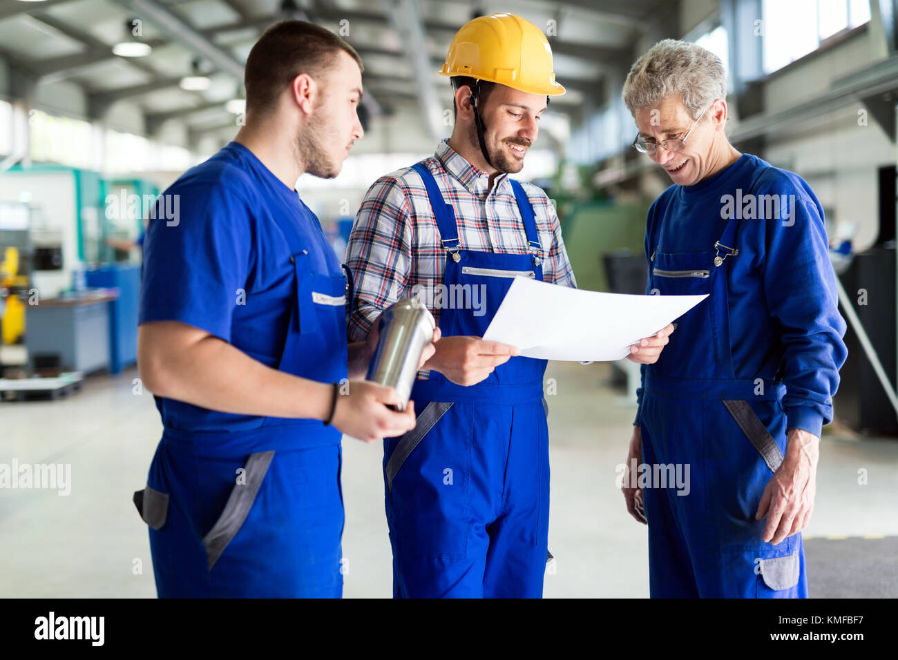 Engineer Teaching Apprentices To Use Computerized cnc metal processing ...