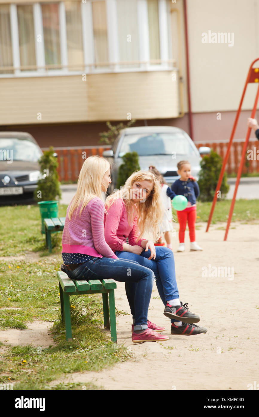 Two mothers talking children hi-res stock photography and images - Alamy