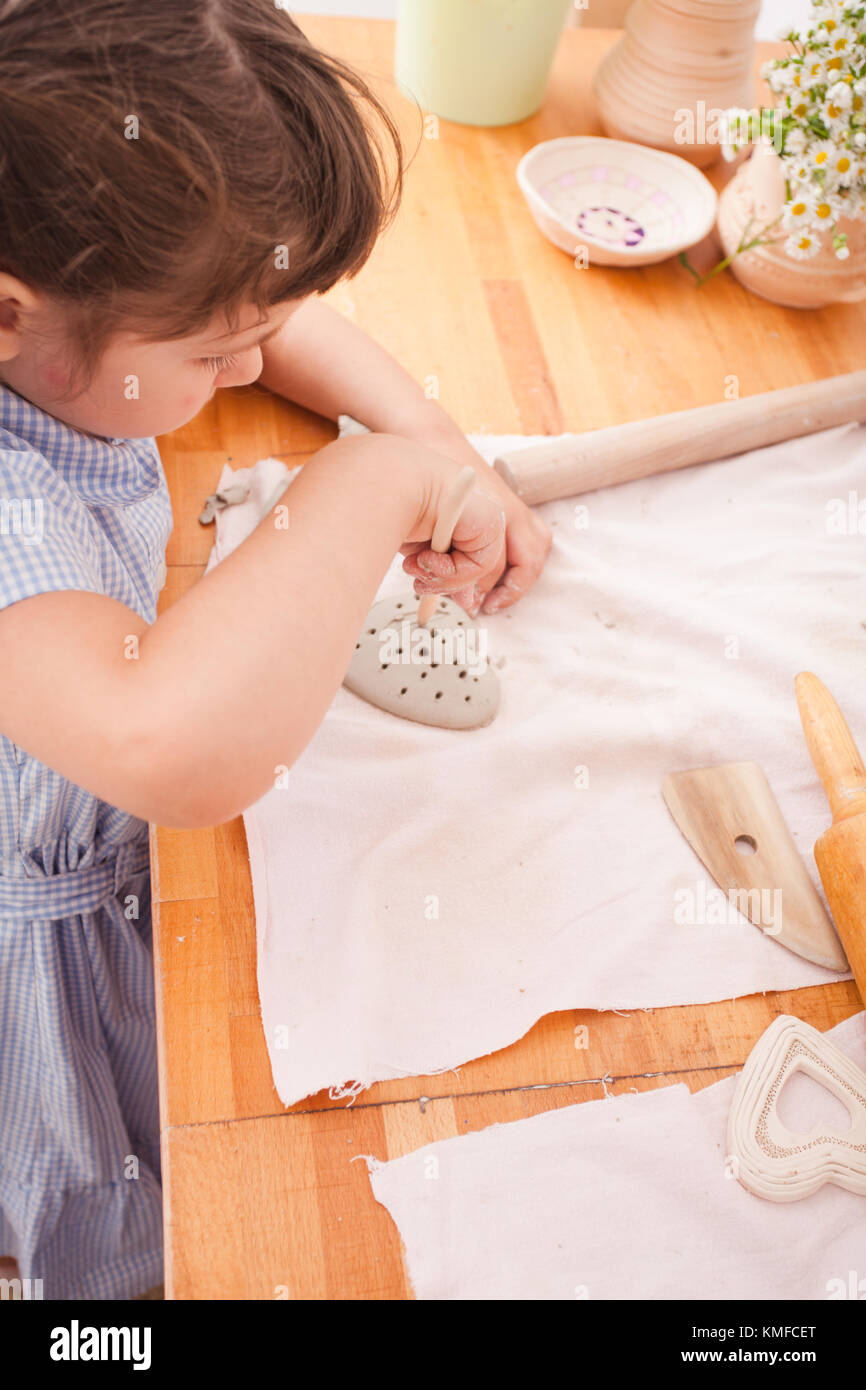 Happy children are engaged with modeling clay Stock Photo - Alamy