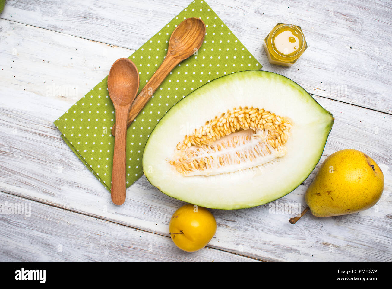 Half cut melon with honey and pears on wood in rustic style Stock Photo ...