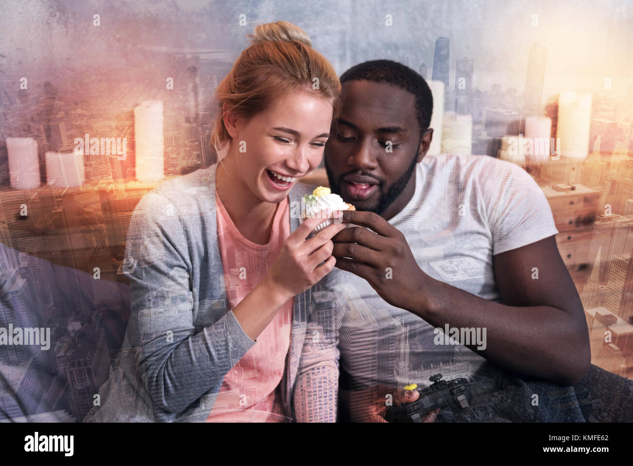 Happy joyful couple looking at the muffin Stock Photo - Alamy