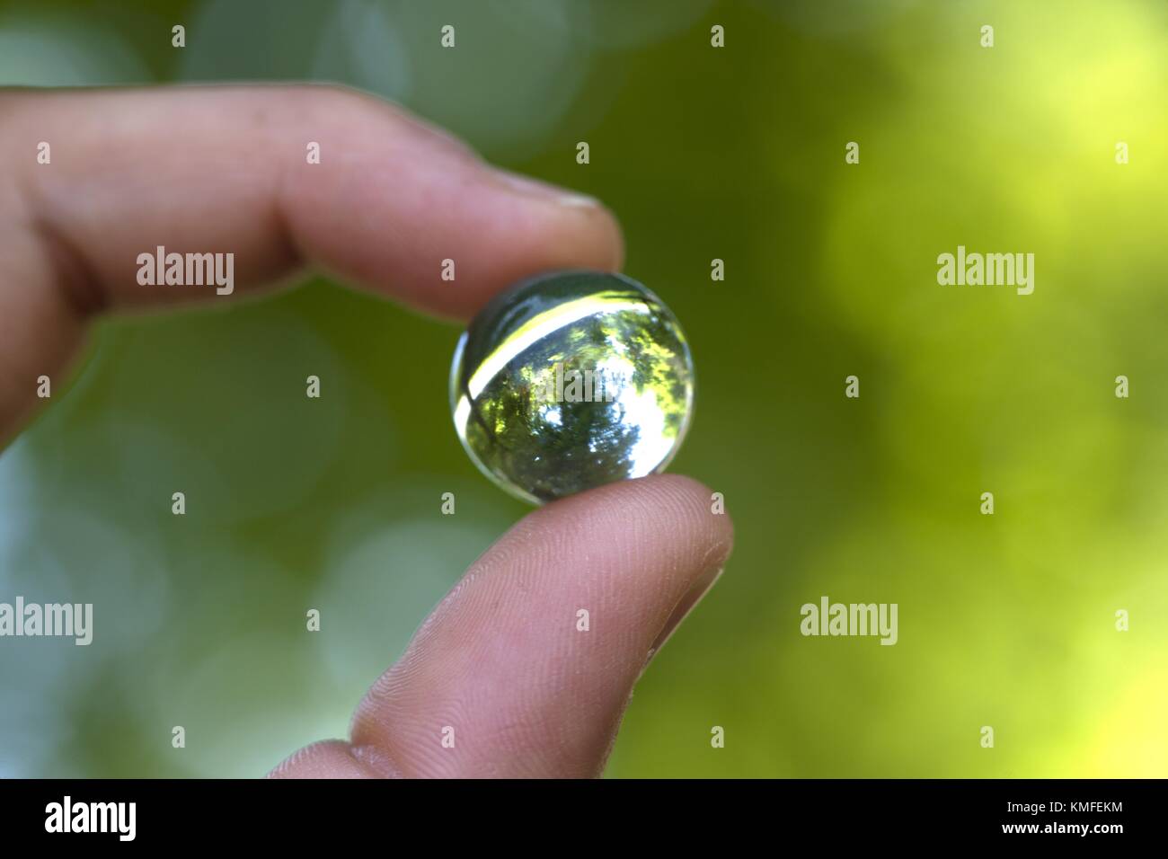 Fingers holding marble hi-res stock photography and images - Alamy