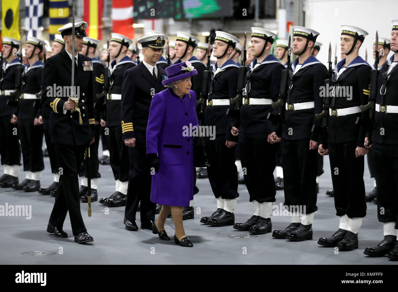 Queen Elizabeth II walks with the ship's commanding officer Captain ...