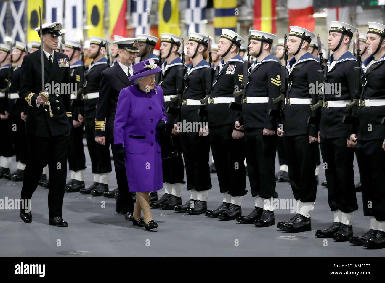 Queen Elizabeth II walks with the ship's commanding officer Captain ...