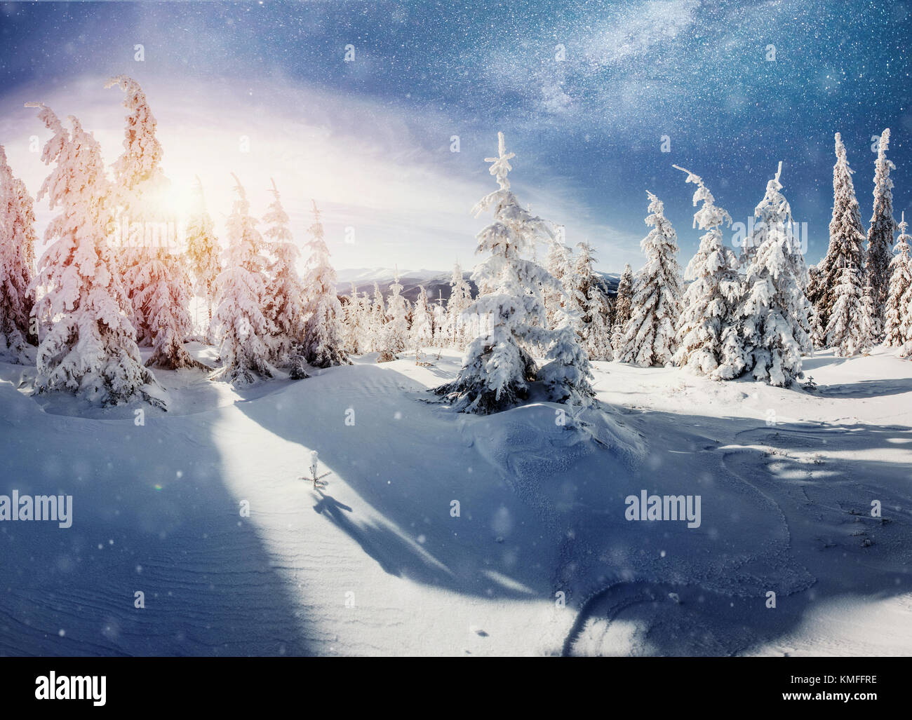 starry sky in winter snowy night. fantastic milky way in the New Year's ...