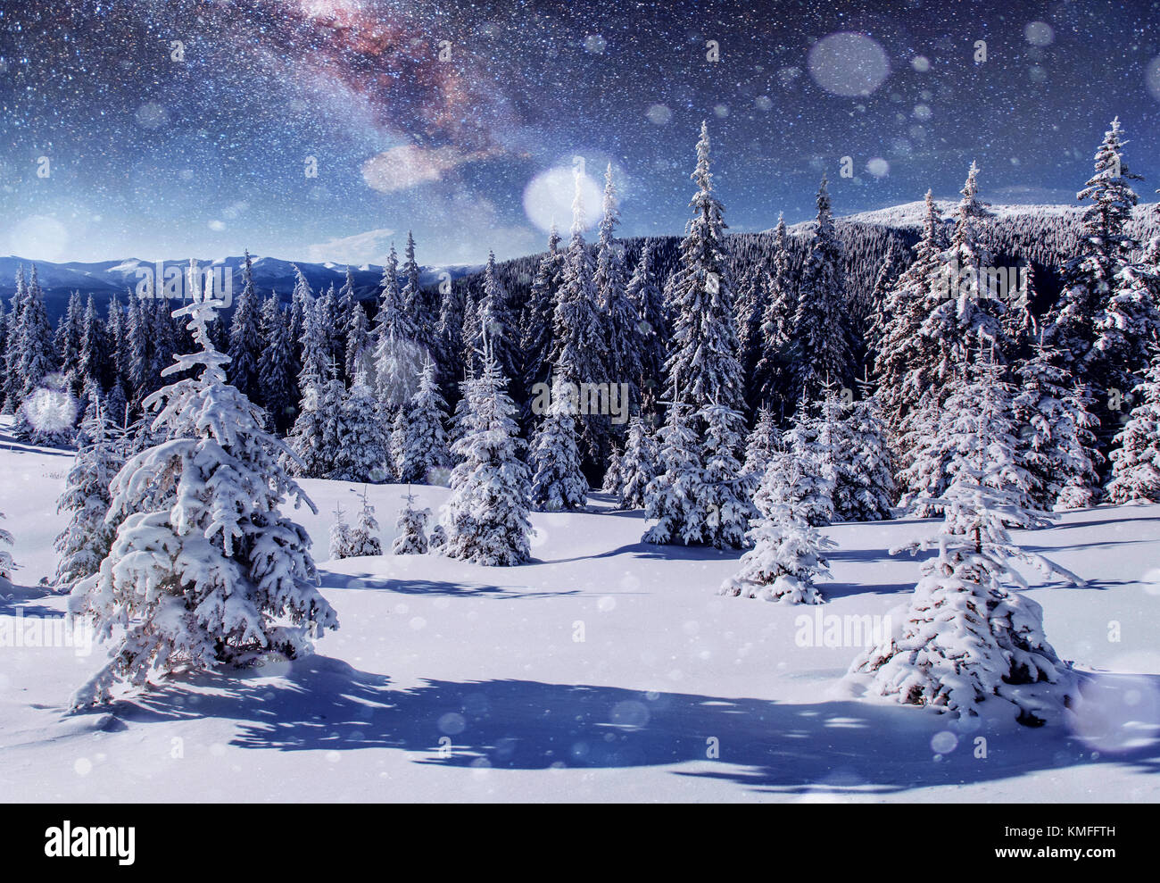 starry sky in winter snowy night. fantastic milky way in the New Year's Eve. Starry sky snowy ...