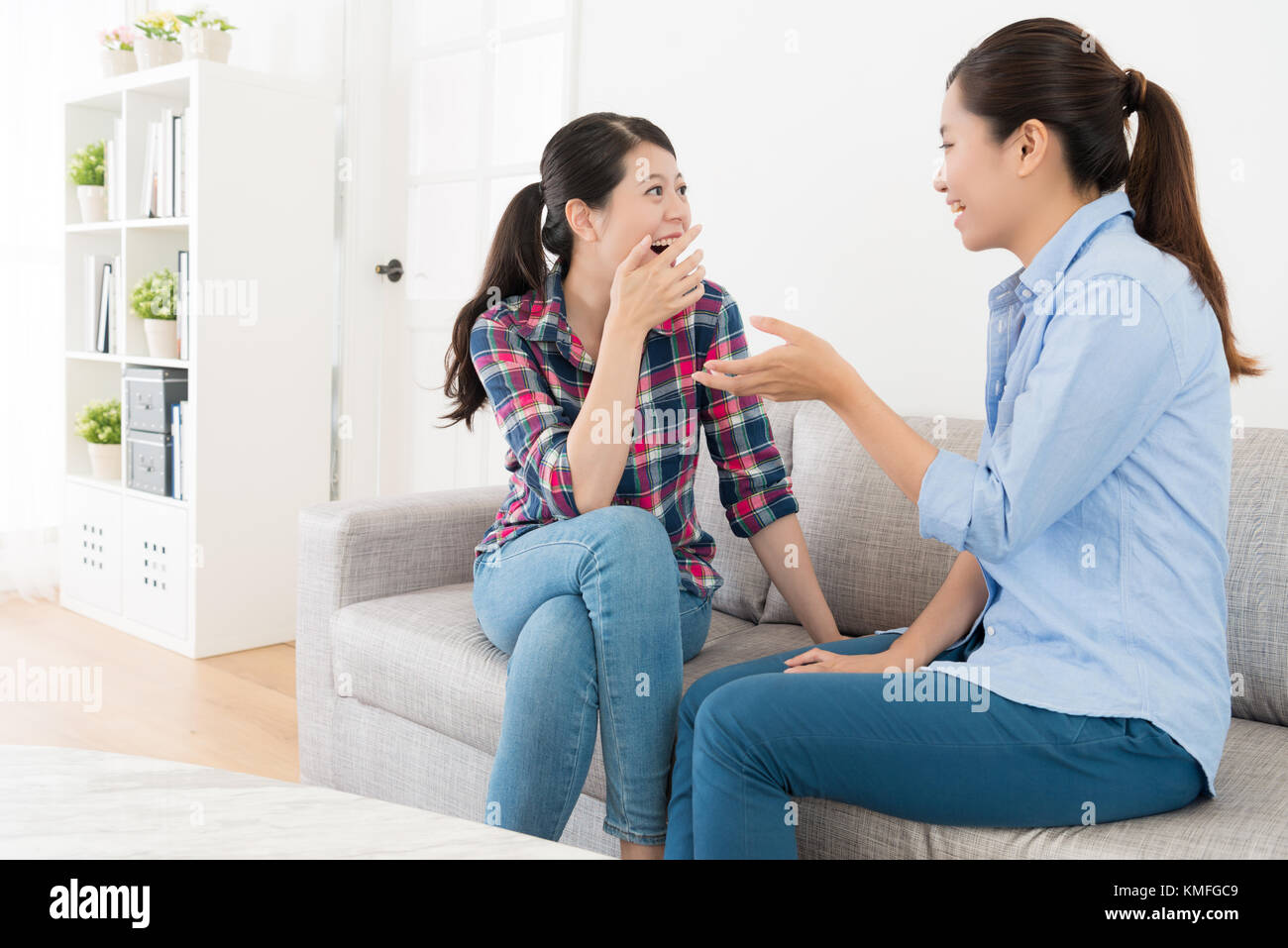 beauty relaxing female friends chatting together in living room at home ...
