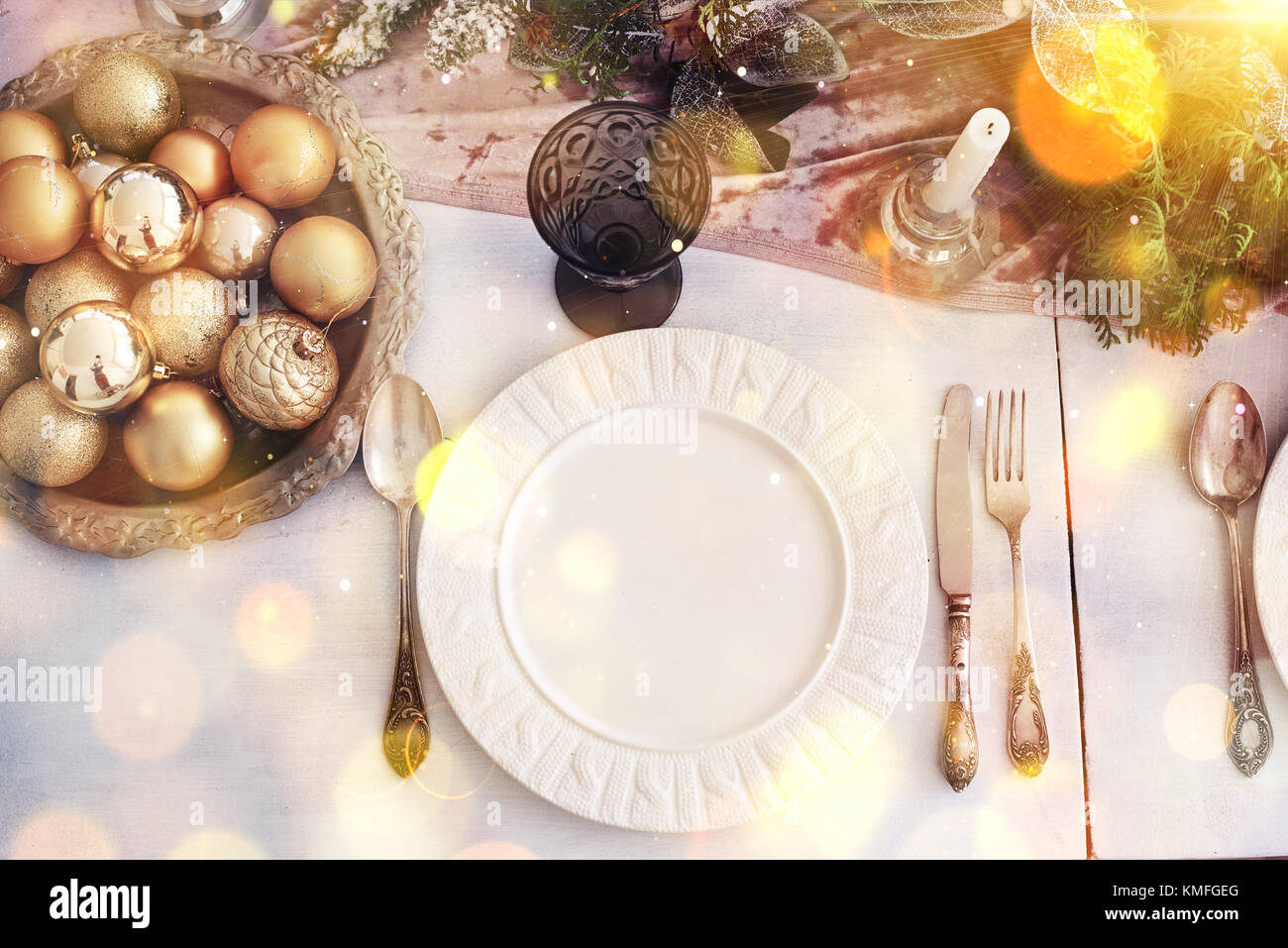 Table served for Christmas dinner in living room, top view. Bokeh light ...