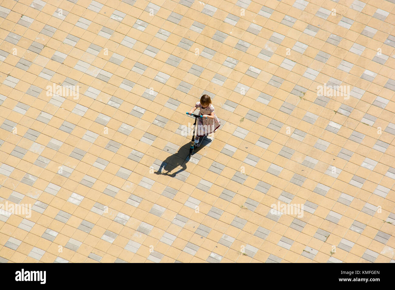 Top view of a child riding scooter on sunny day Stock Photo - Alamy