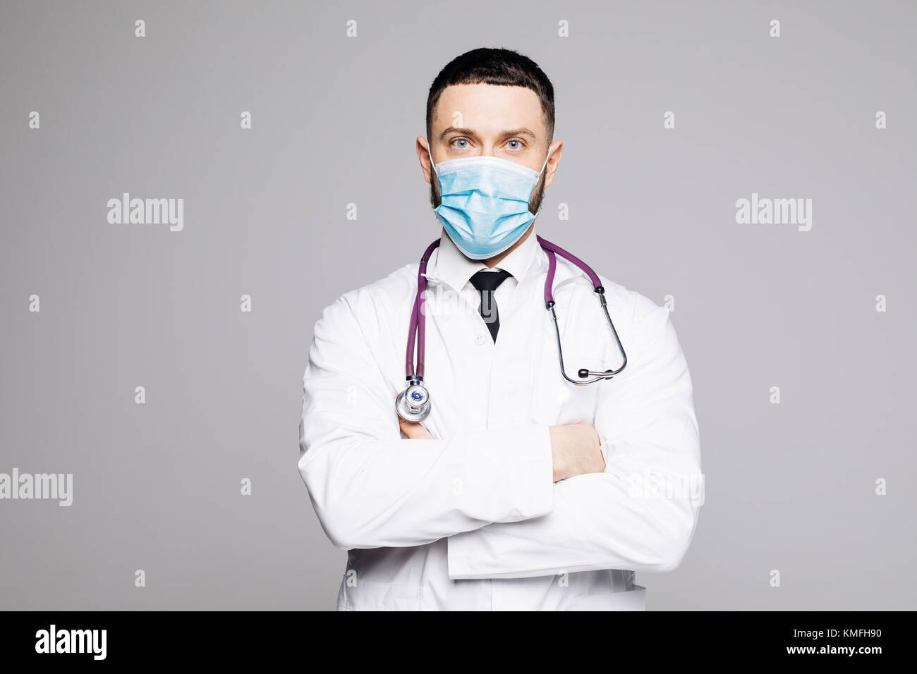 Portrait of a handsome beard doctor in scrubs with stethoscope and mask ...