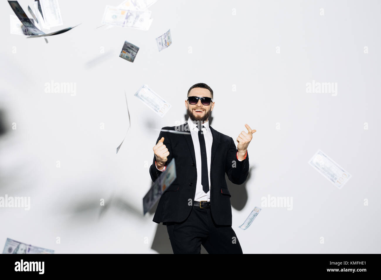 Businessman standing in the rain of money Stock Photo - Alamy