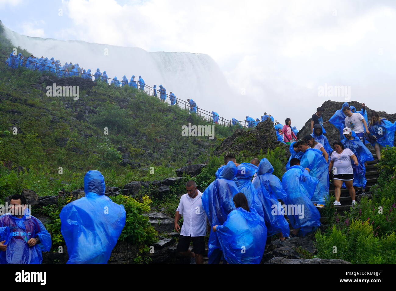 A line of visitors (tourists) walking towards the falls at Niagara ...