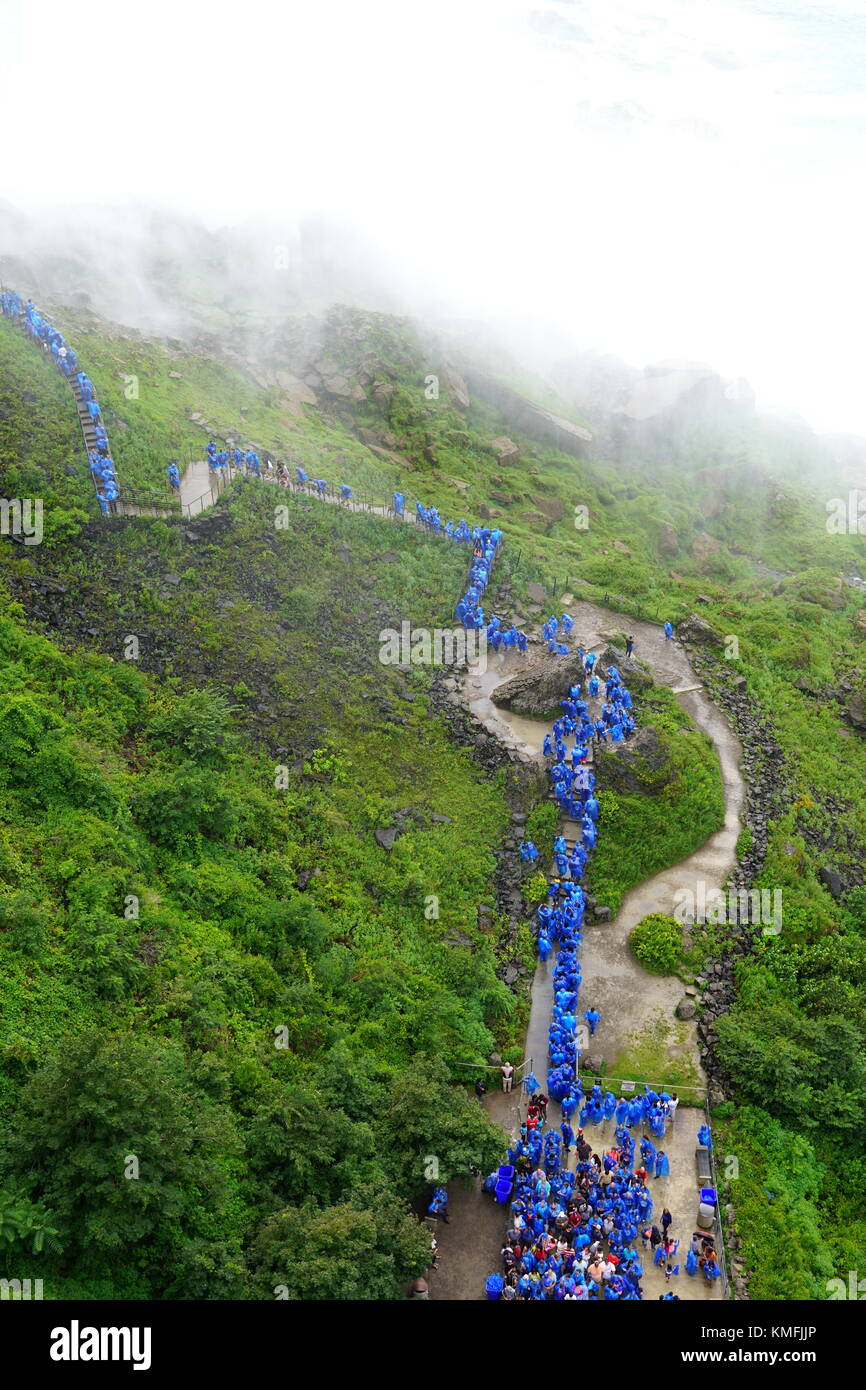 Aerial view of a line of visitors (tourists) walking toward the falls ...