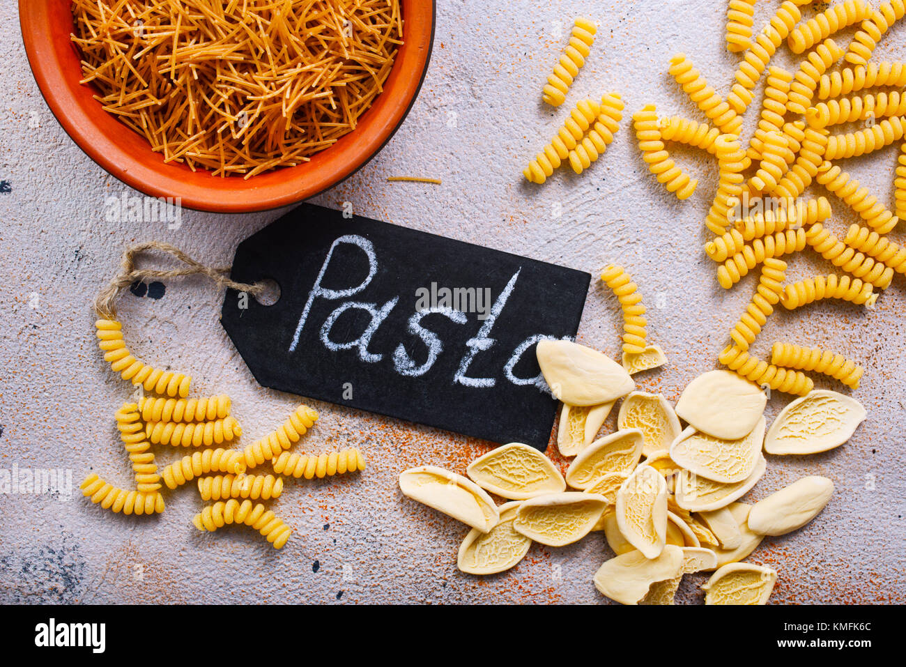 raw pasta in bowls and on a table Stock Photo - Alamy