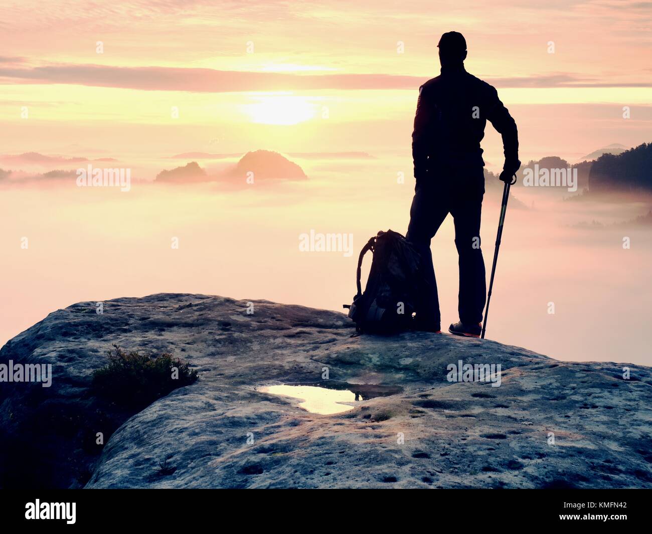 Man silhouette stay on sharp rock peak. Satisfy hiker enjoy view. Tall ...