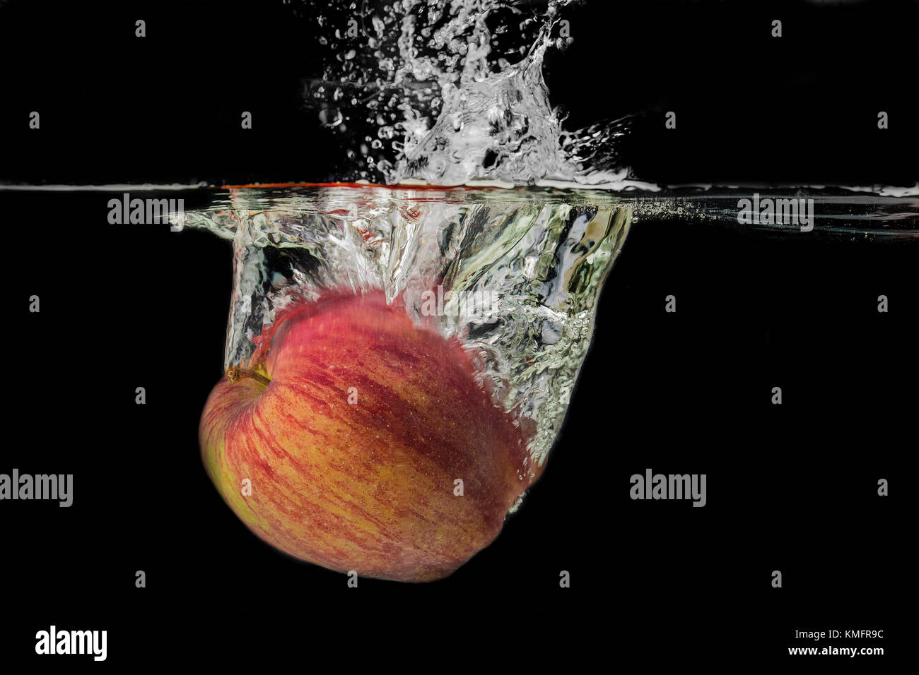 Apple falls into the water and makes a splash Stock Photo - Alamy