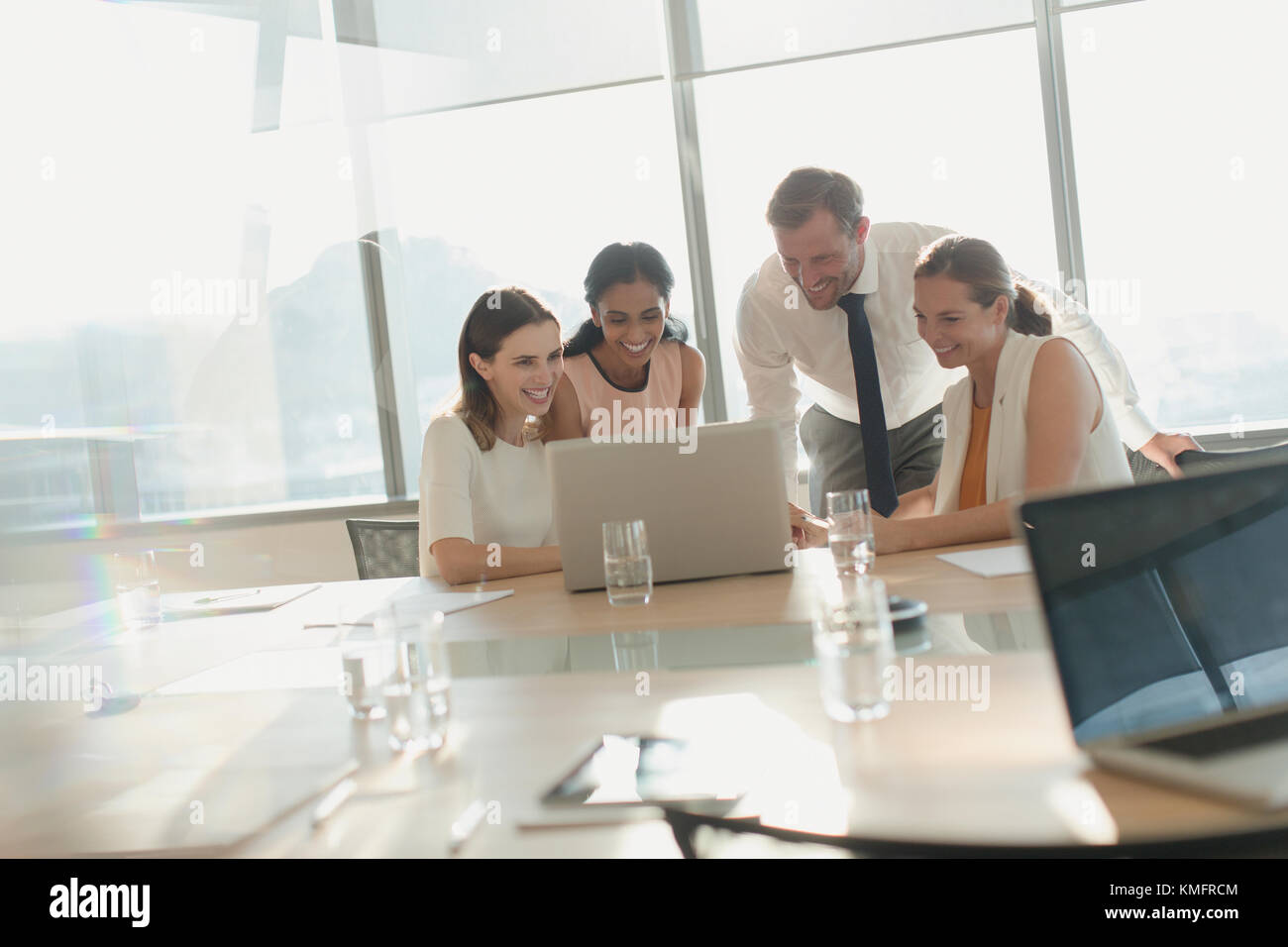 Business people working at laptop in conference room meeting Stock ...