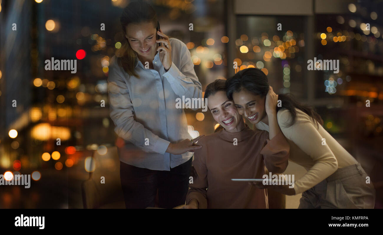 Happy businesswomen celebrating, working late in office at night Stock ...