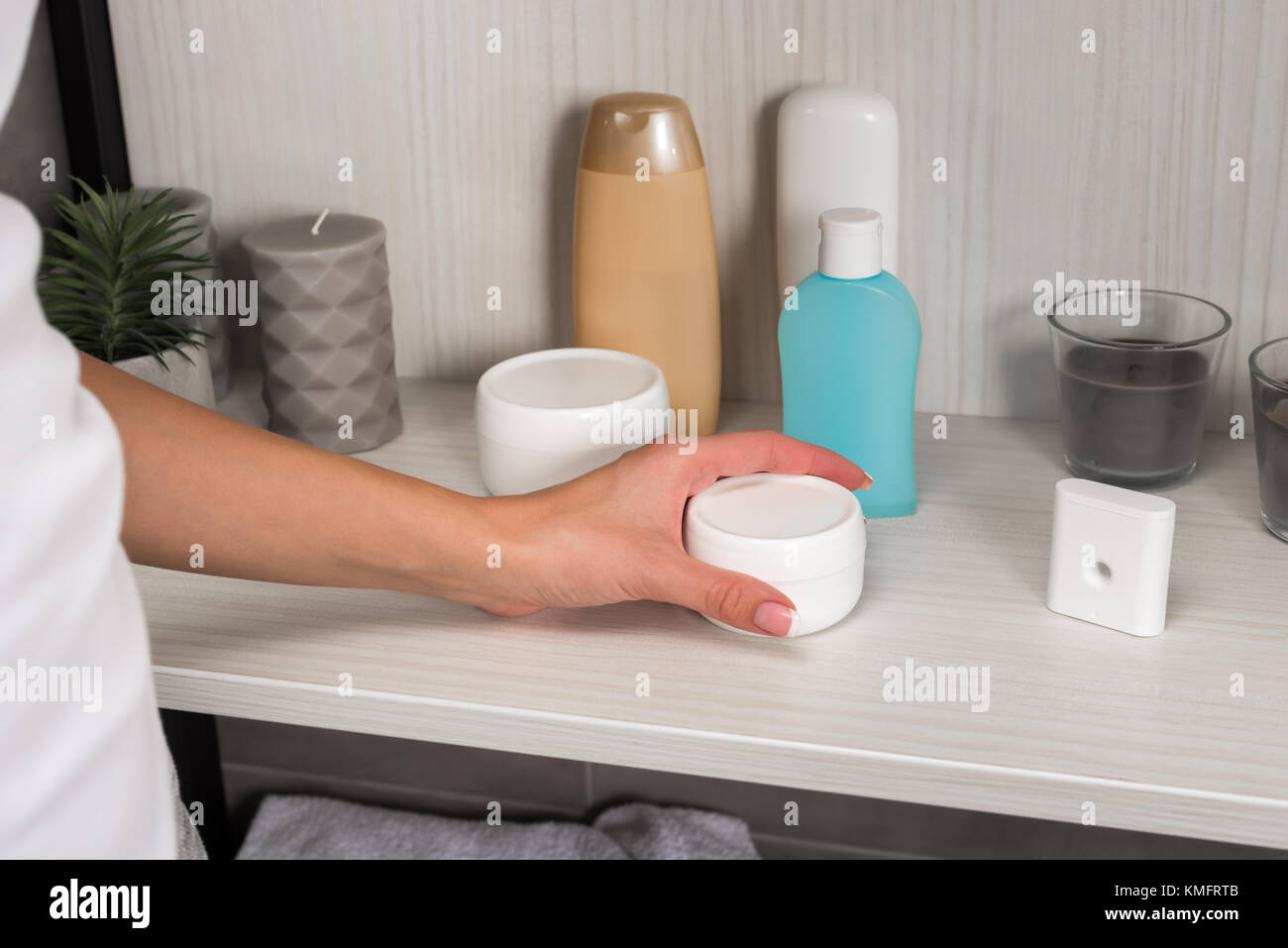 woman taking cream from shelf Stock Photo - Alamy